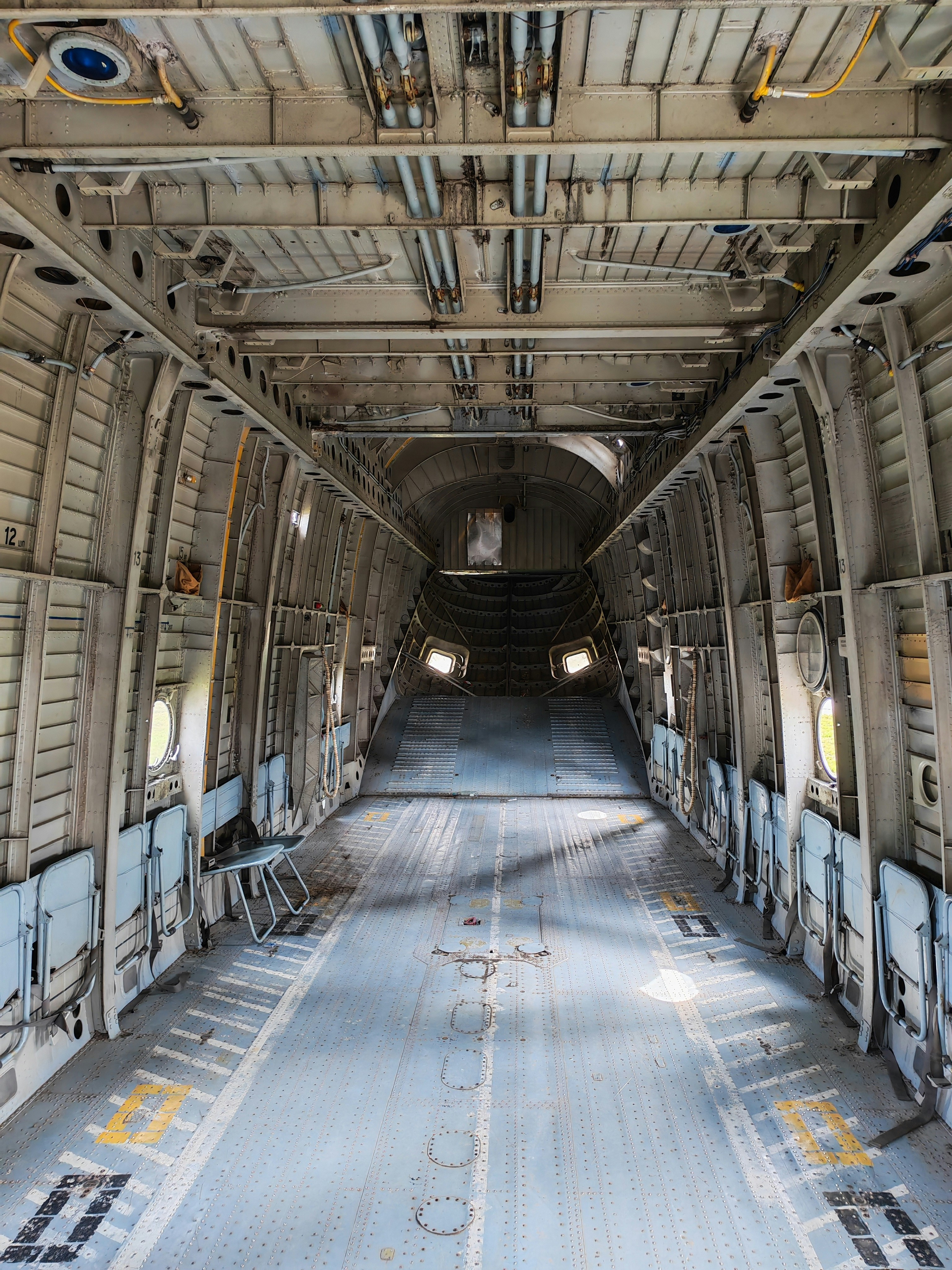 Interior of an empty cargo airplane with metal walls.