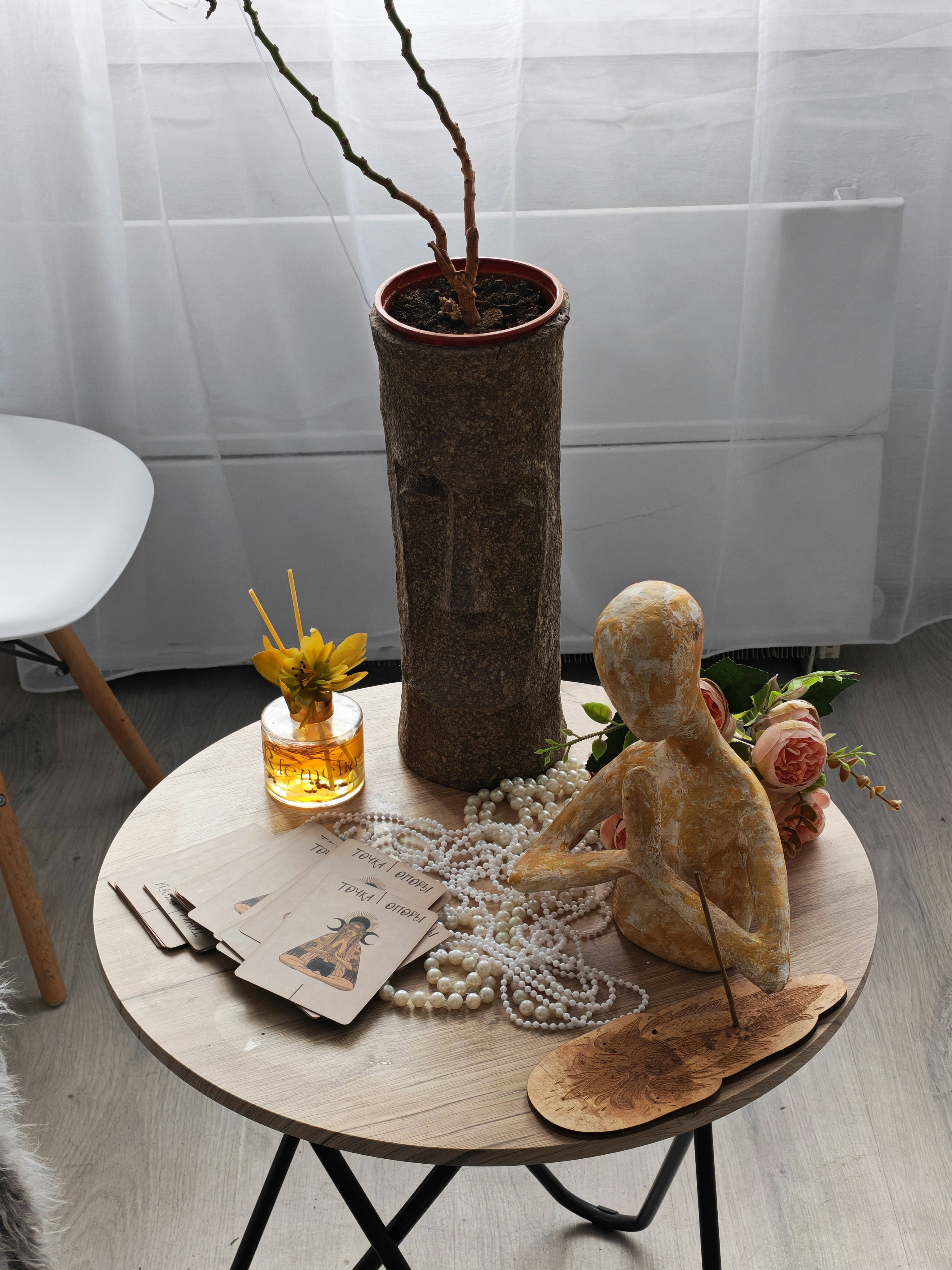 Still Life Reverie: A Rustic Tabletop Scene with Aged Vase and Pebbled Beads