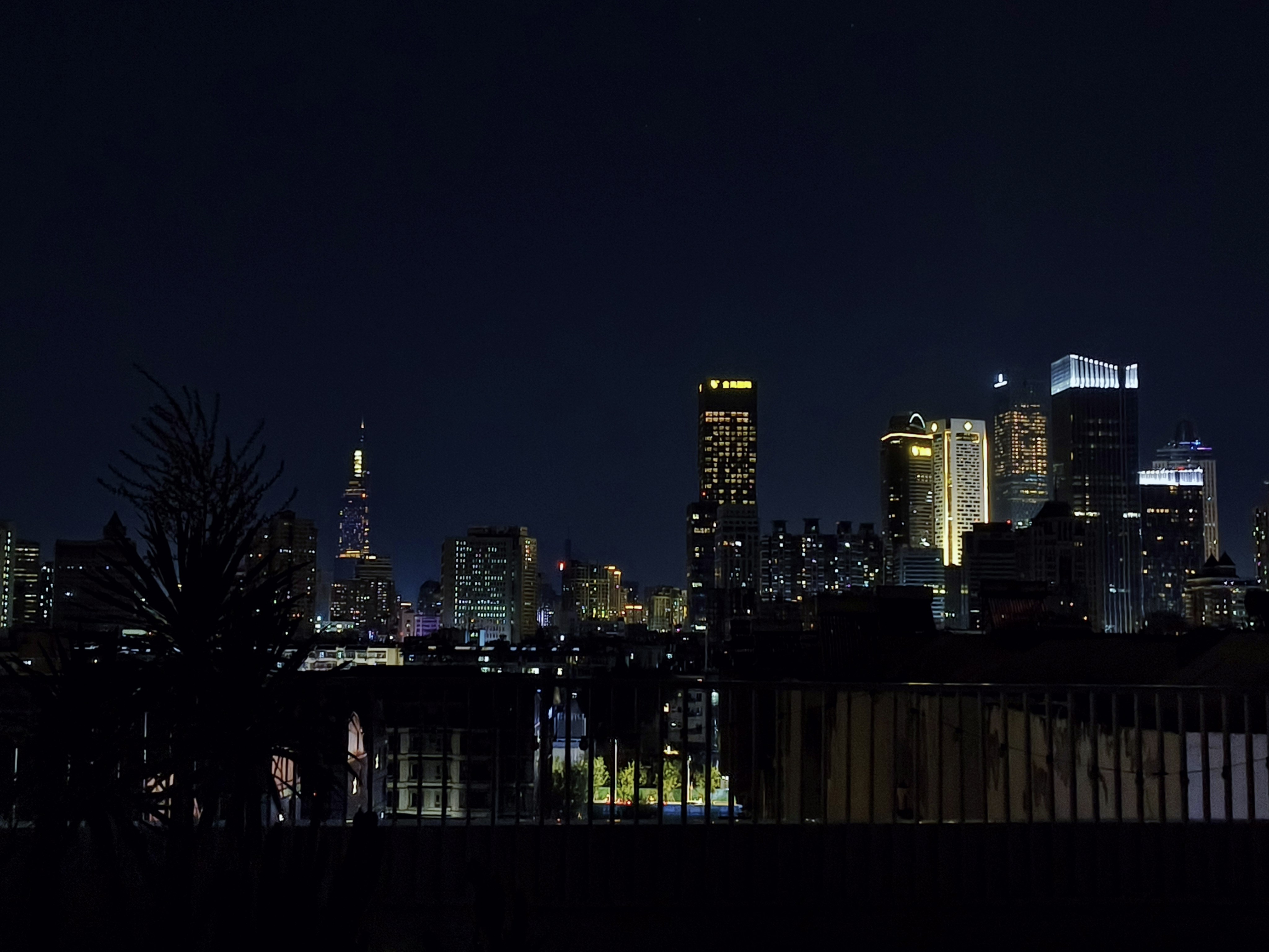 City skyline illuminated at night with dark sky
