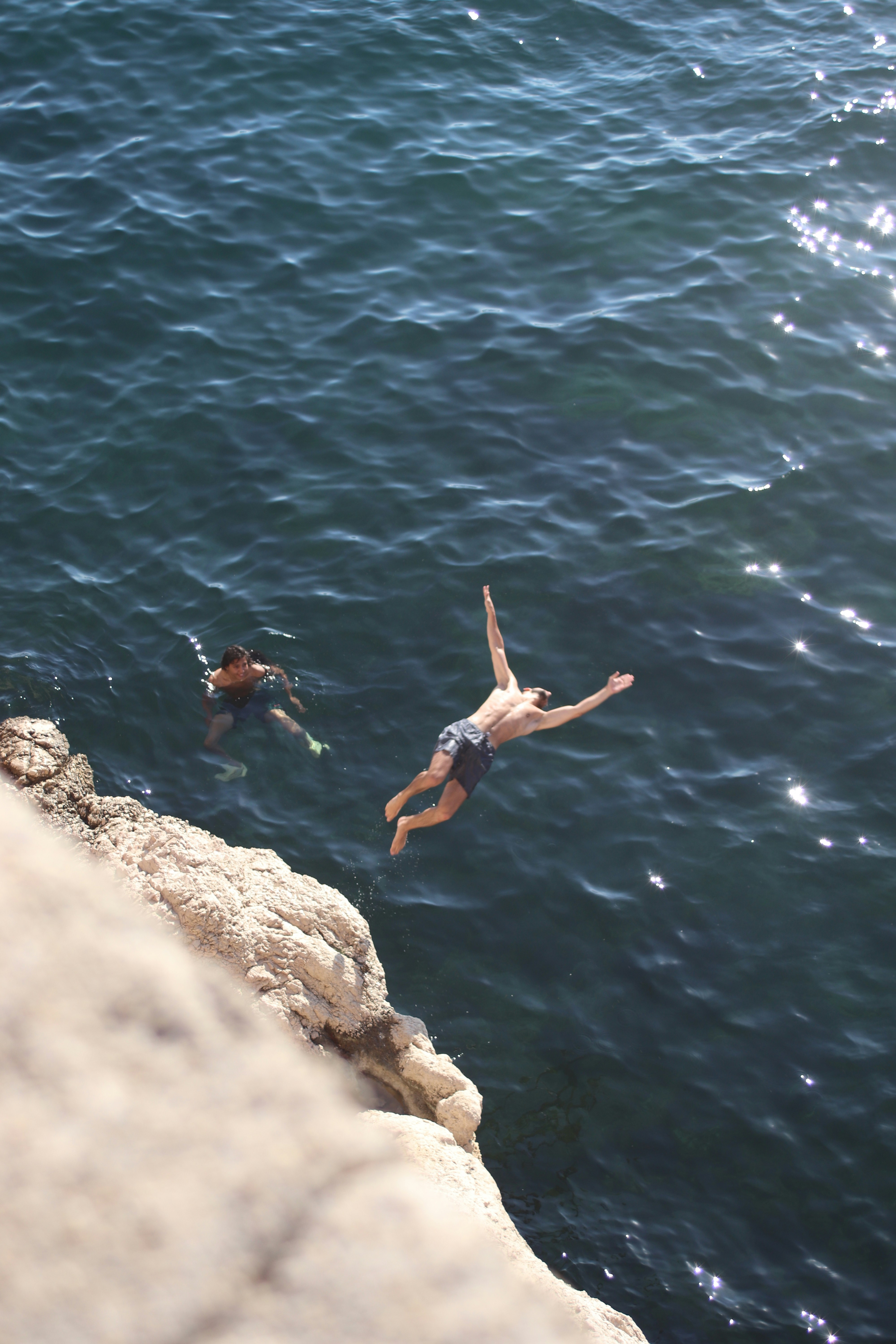 Azure Leap from a sunlit cliff into the deep blue sea