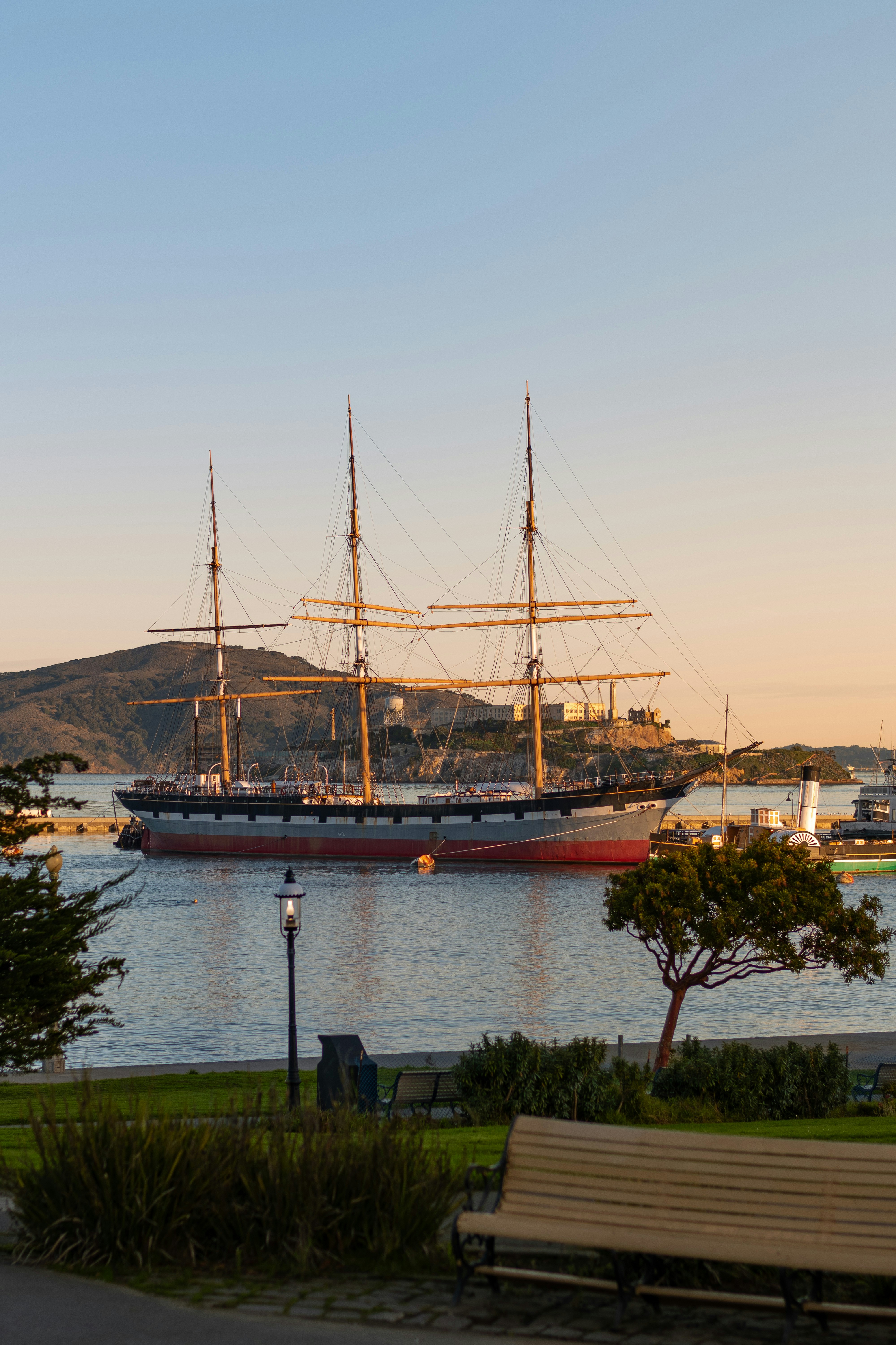 Balclutha | Historic sailing ship docked in a bay at sunset