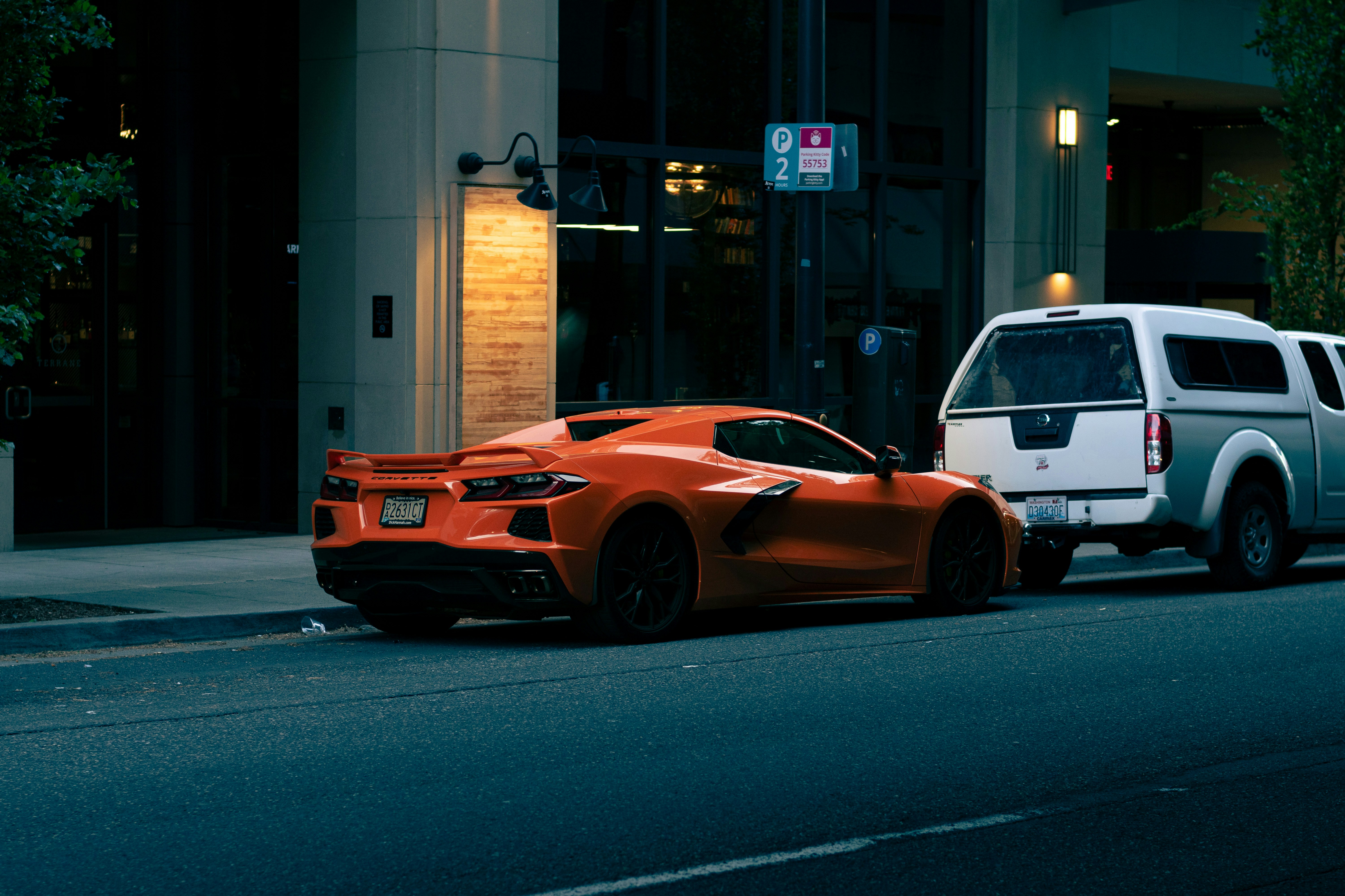 Corvette in downtown Portland | Orange sports car parked on a city street.