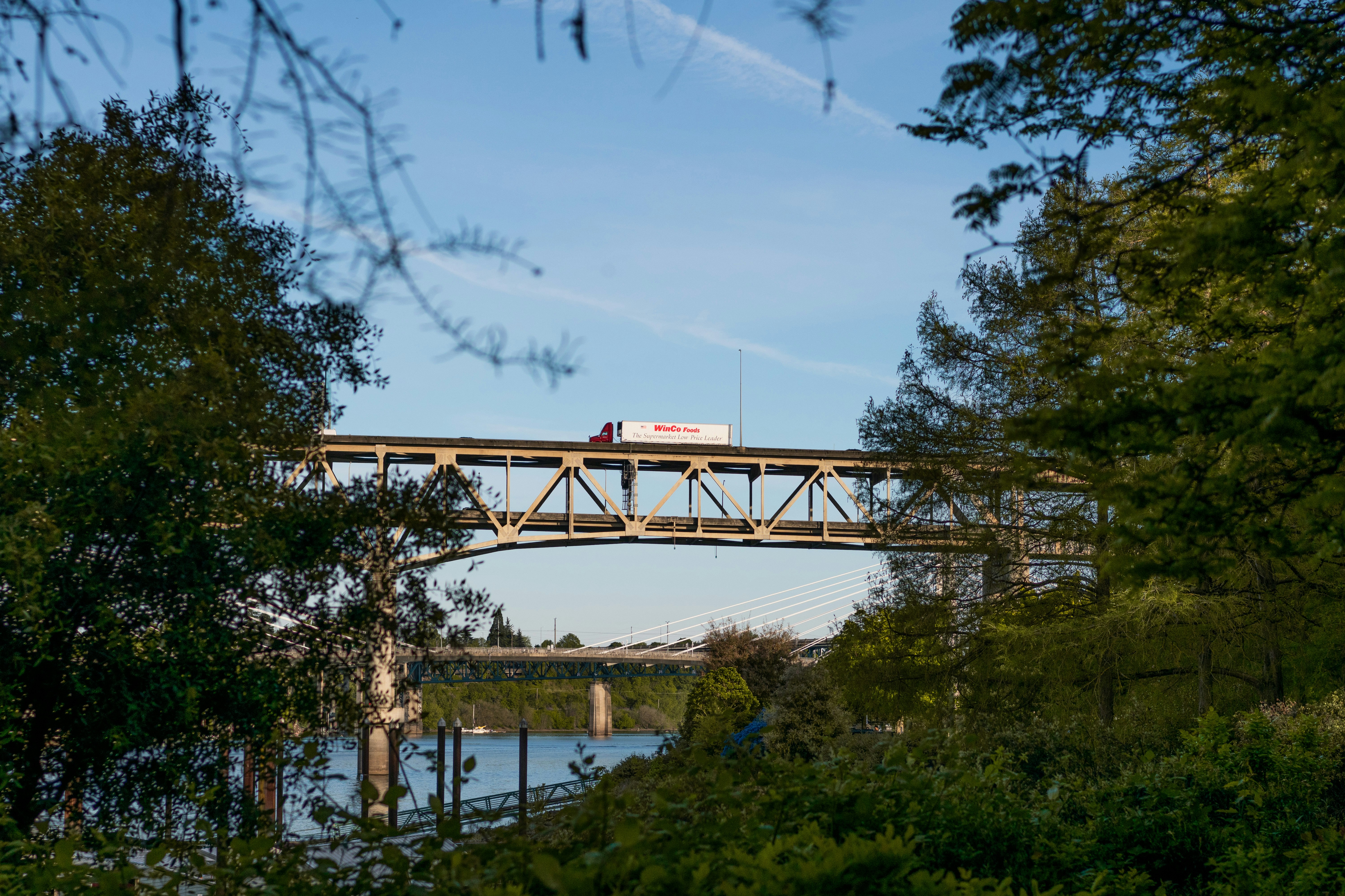 Marquam Bridge over the Willamette River in Portland | Truck crossing a bridge over a body of water.