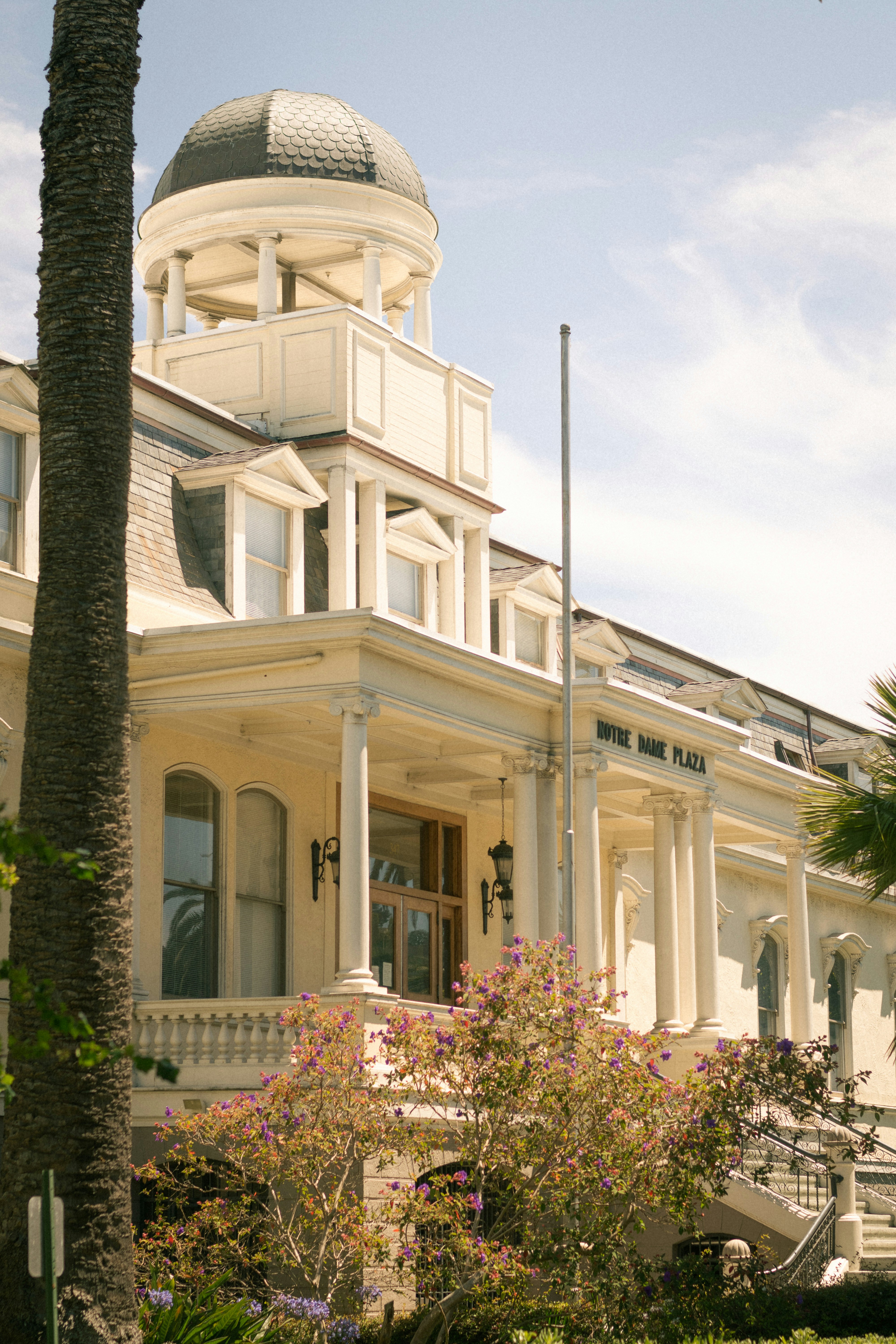 Notre Dame Plaza in Mission district, San Francisco | Elegant historic building with a domed roof and columns.