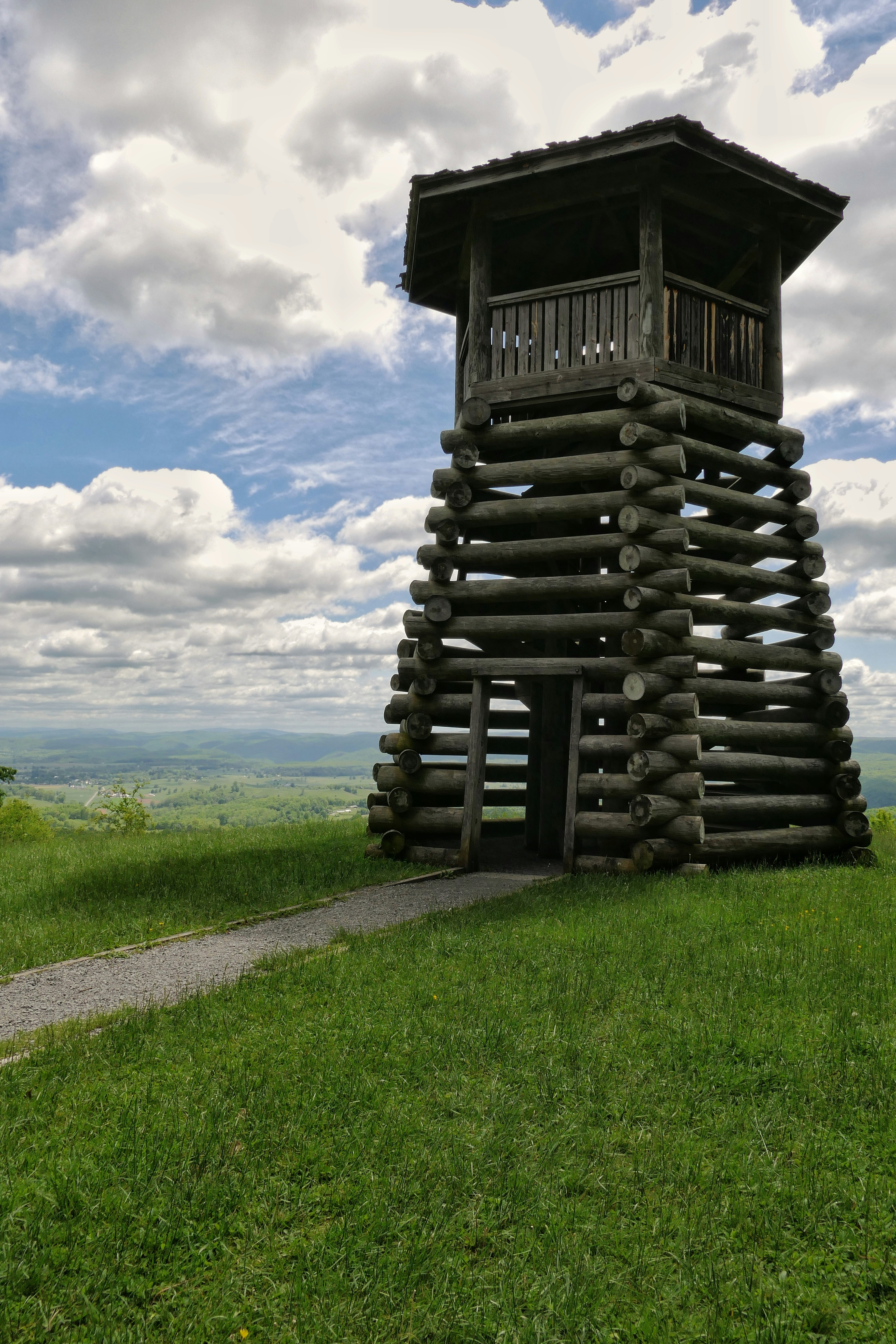 historic old log tower | Wooden observation tower on a grassy hill