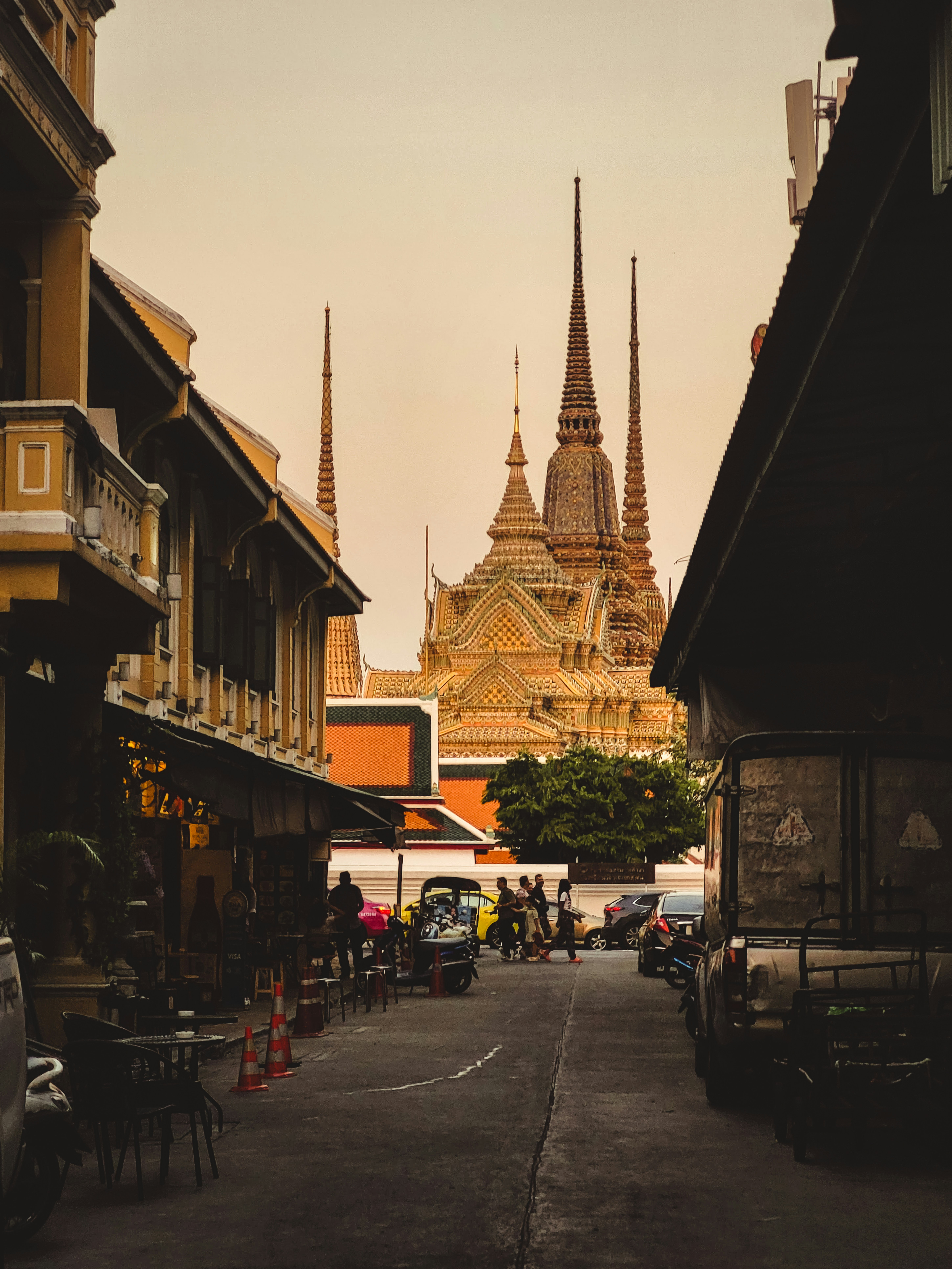 Ornate thai temples rise above a street scene.