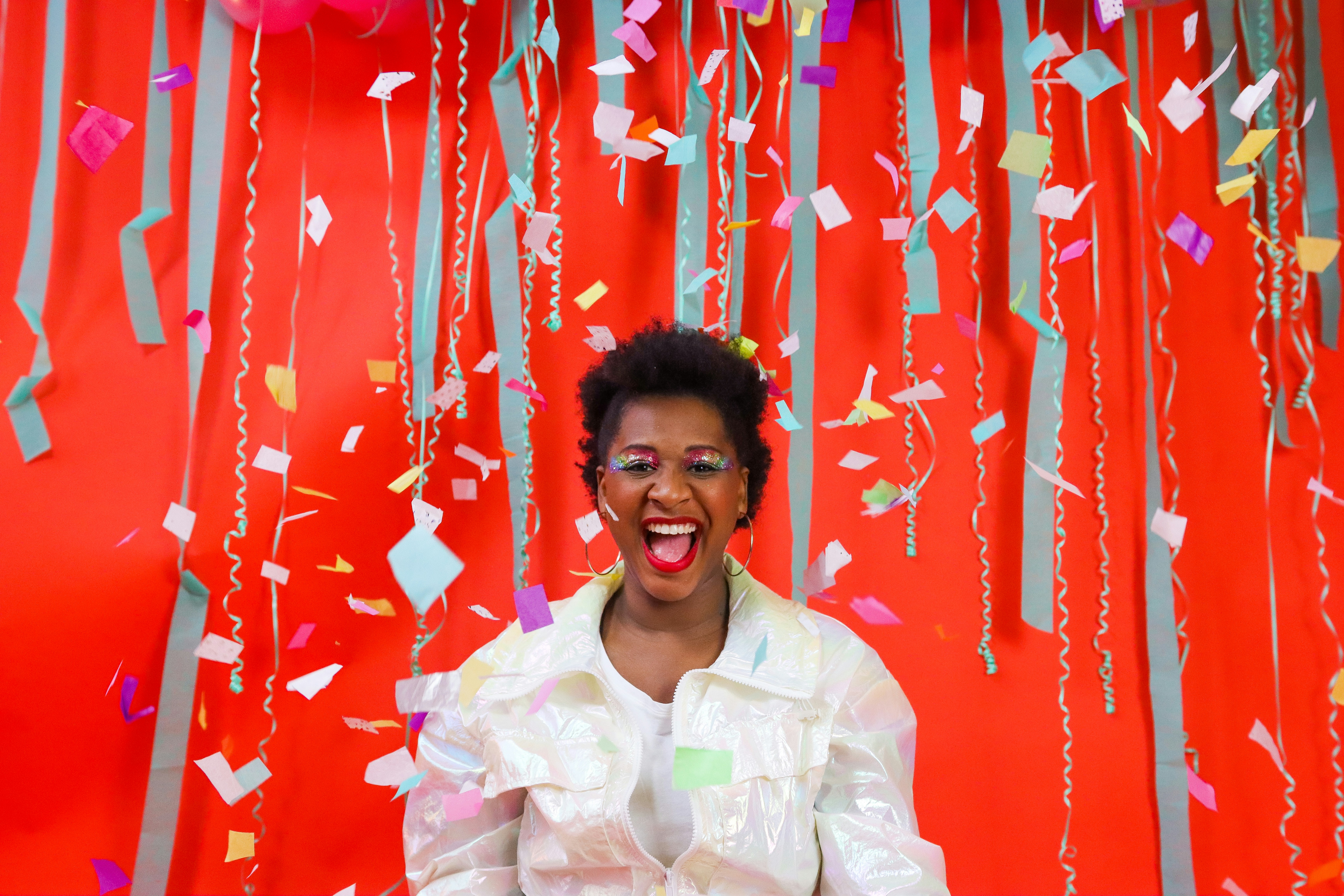 80's Rainbow Glitter | Woman with confetti and streamers celebrating