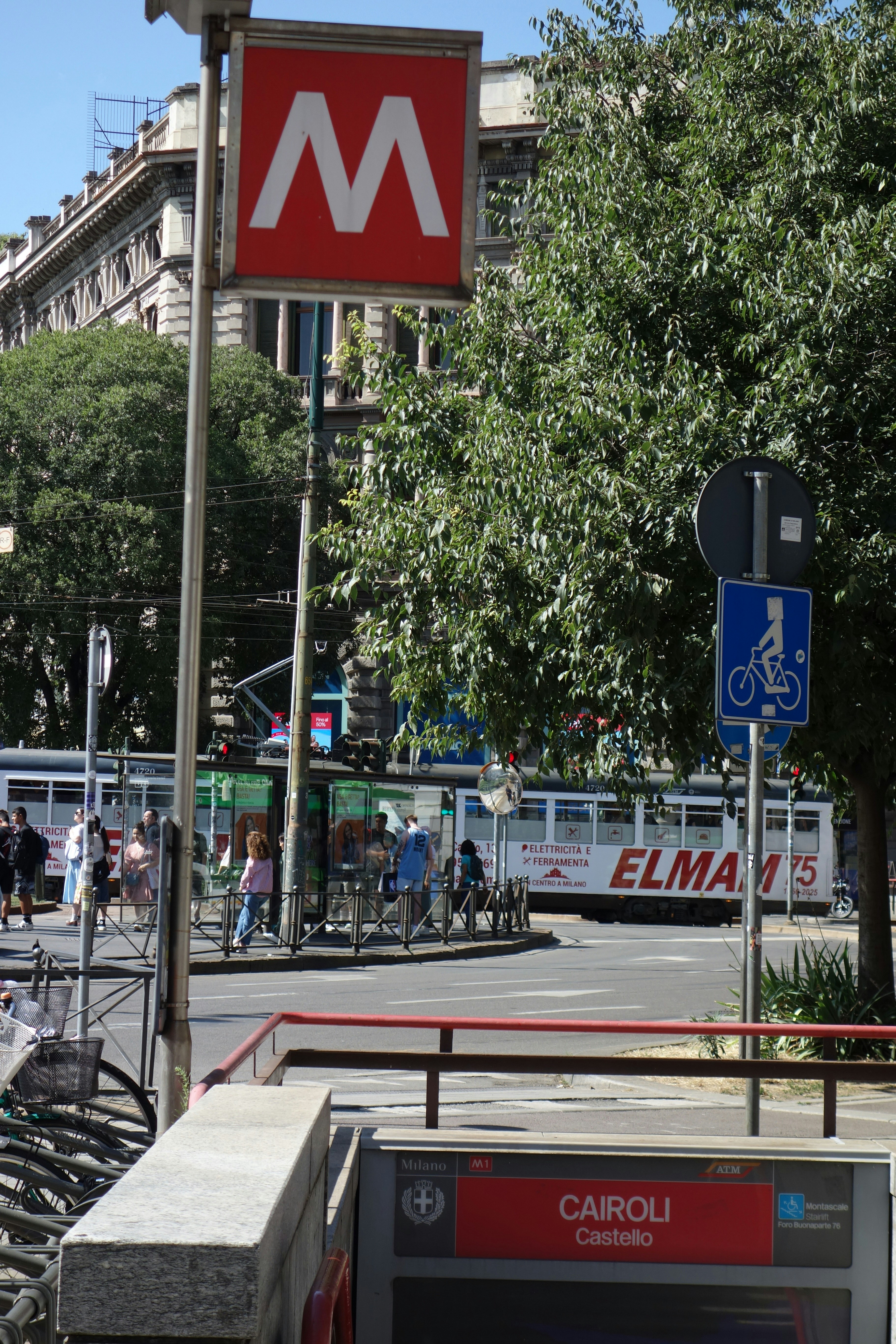 Metro station entrance with public transport and trees