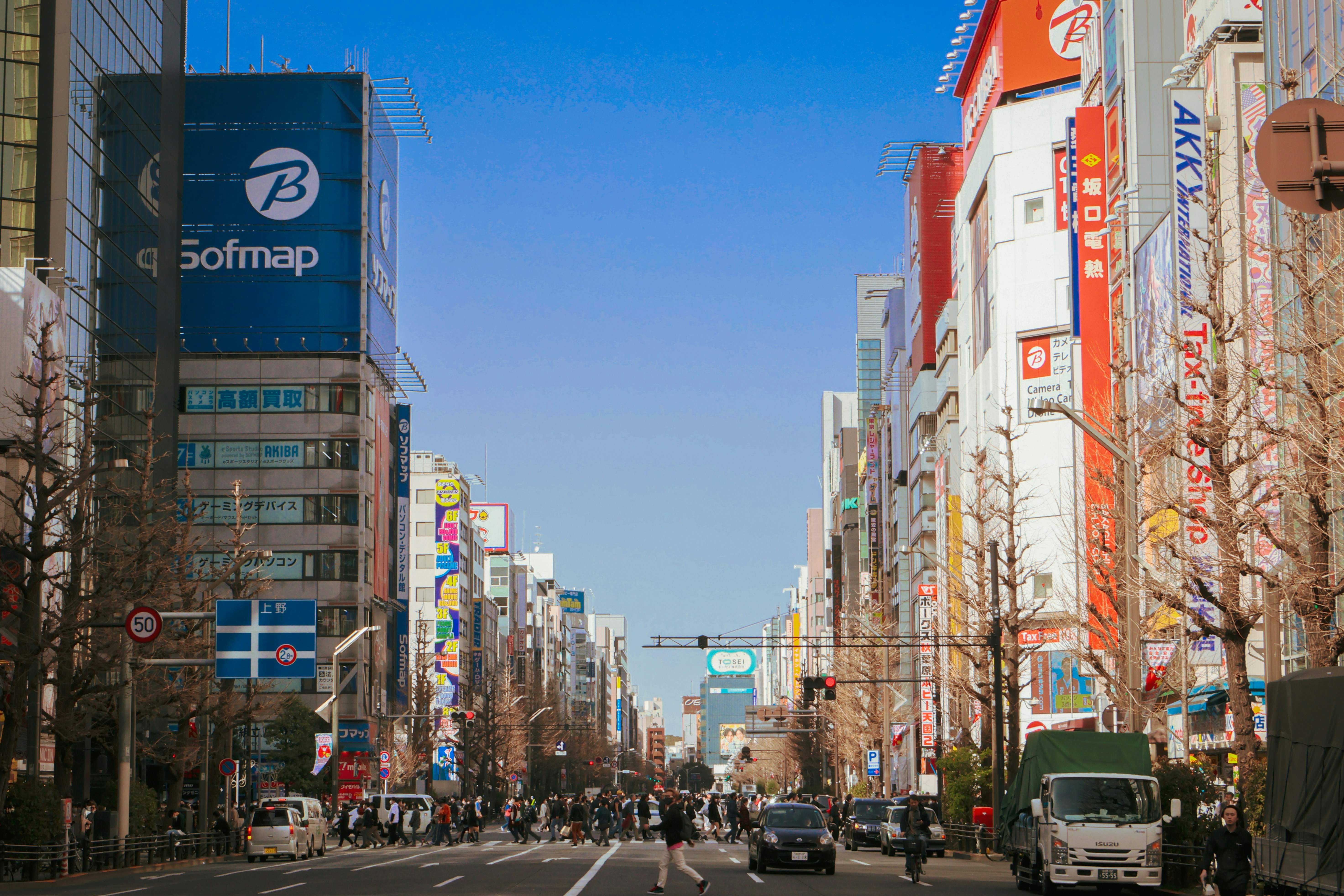 Busy city street with tall buildings and cars.