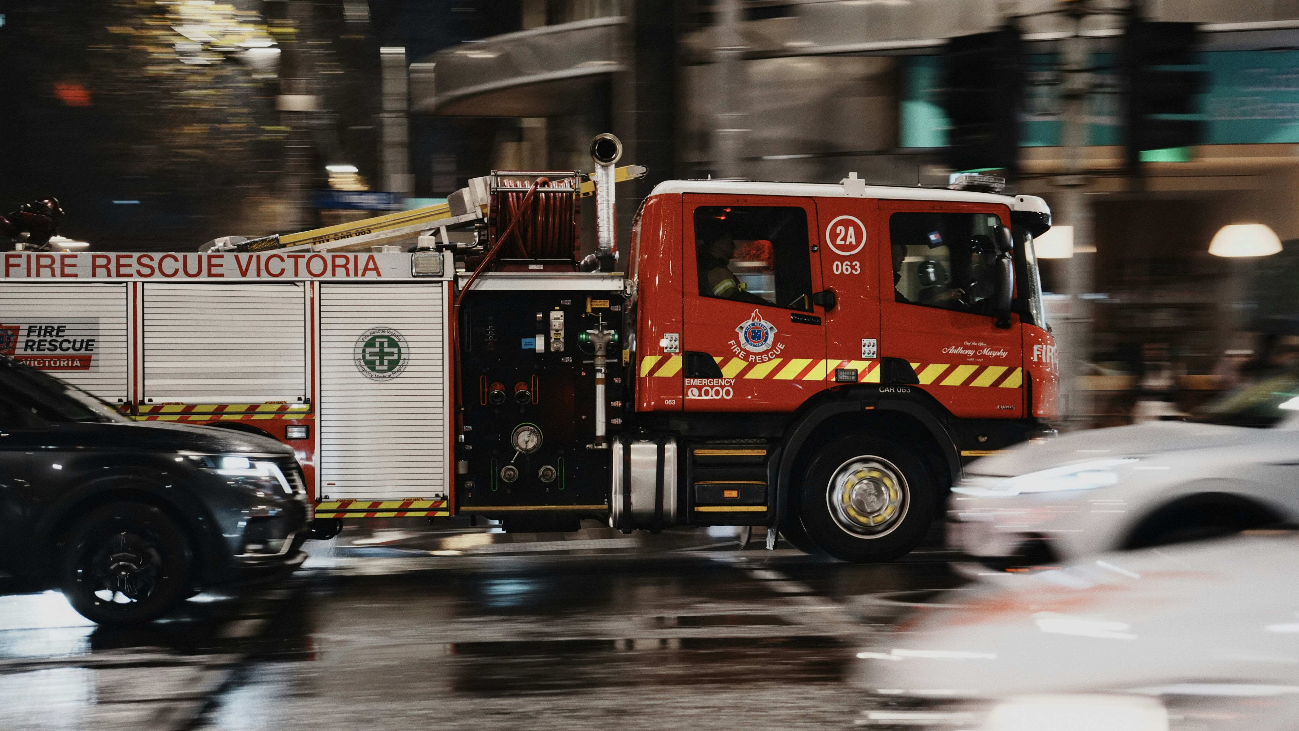 Night Rush on Wet Streets: Red Fire Engine in Motion