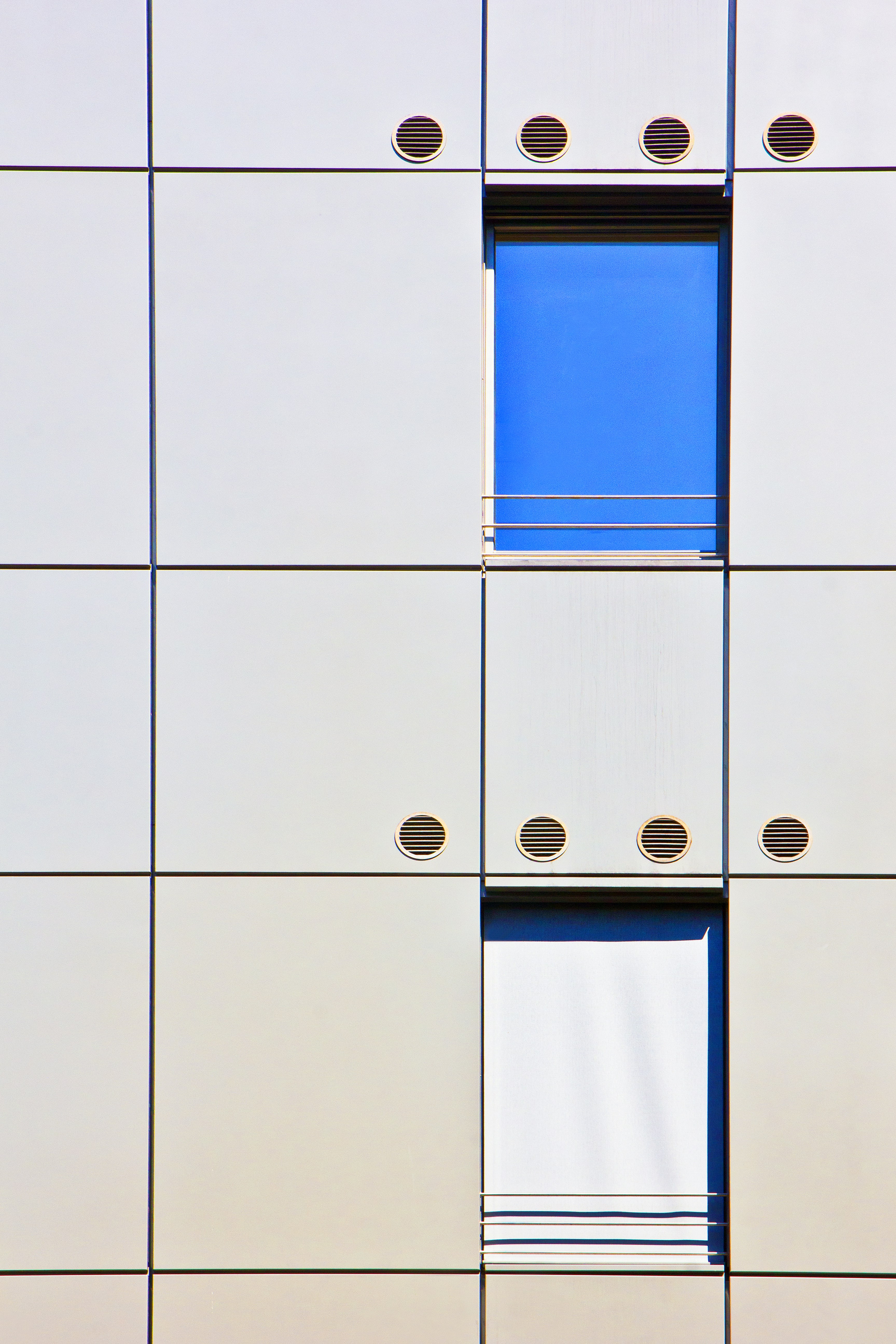 Modern building facade with blue and white windows