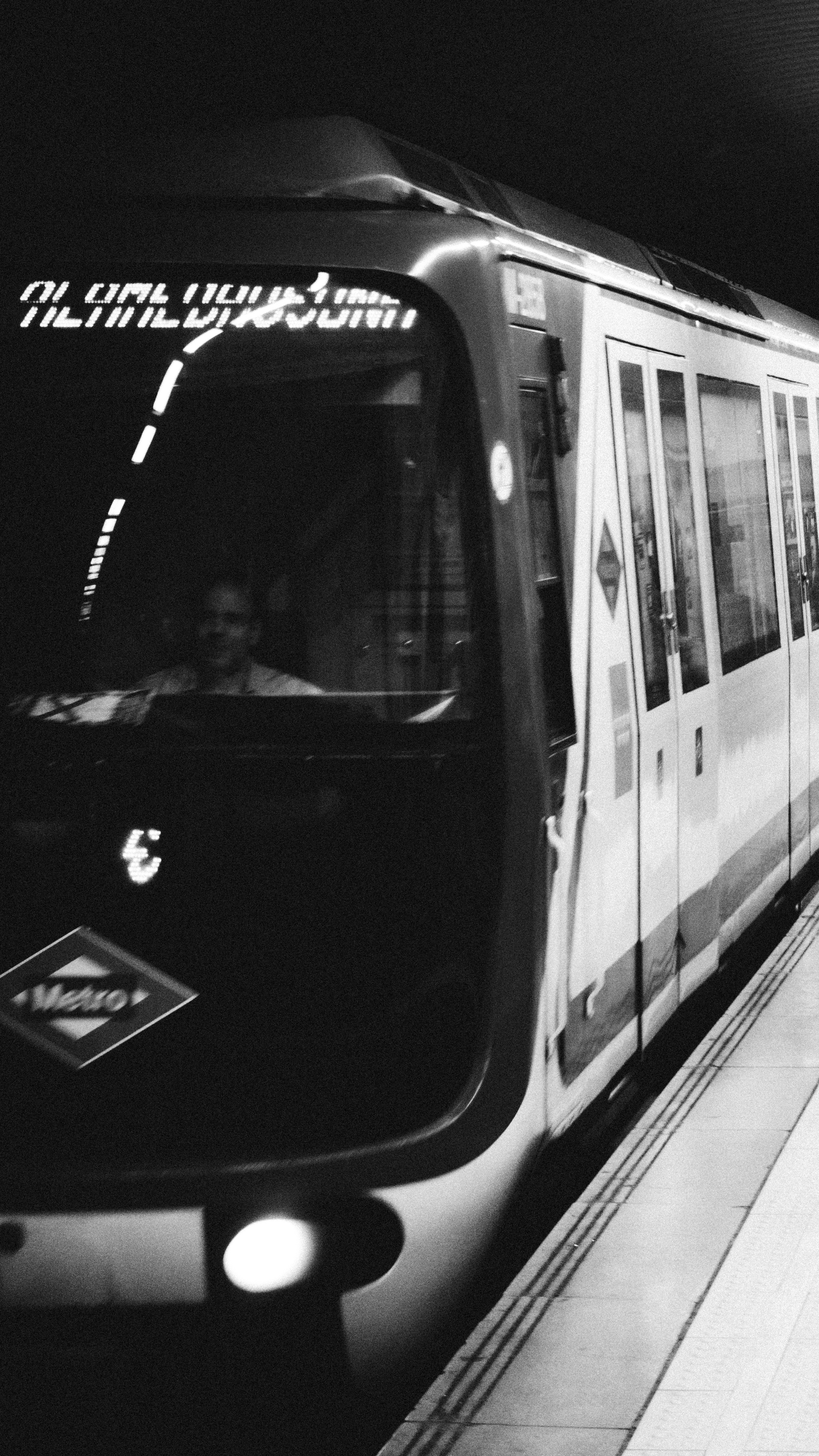 Madrid - Aug 2025 | A train waits at a station platform in black and white.