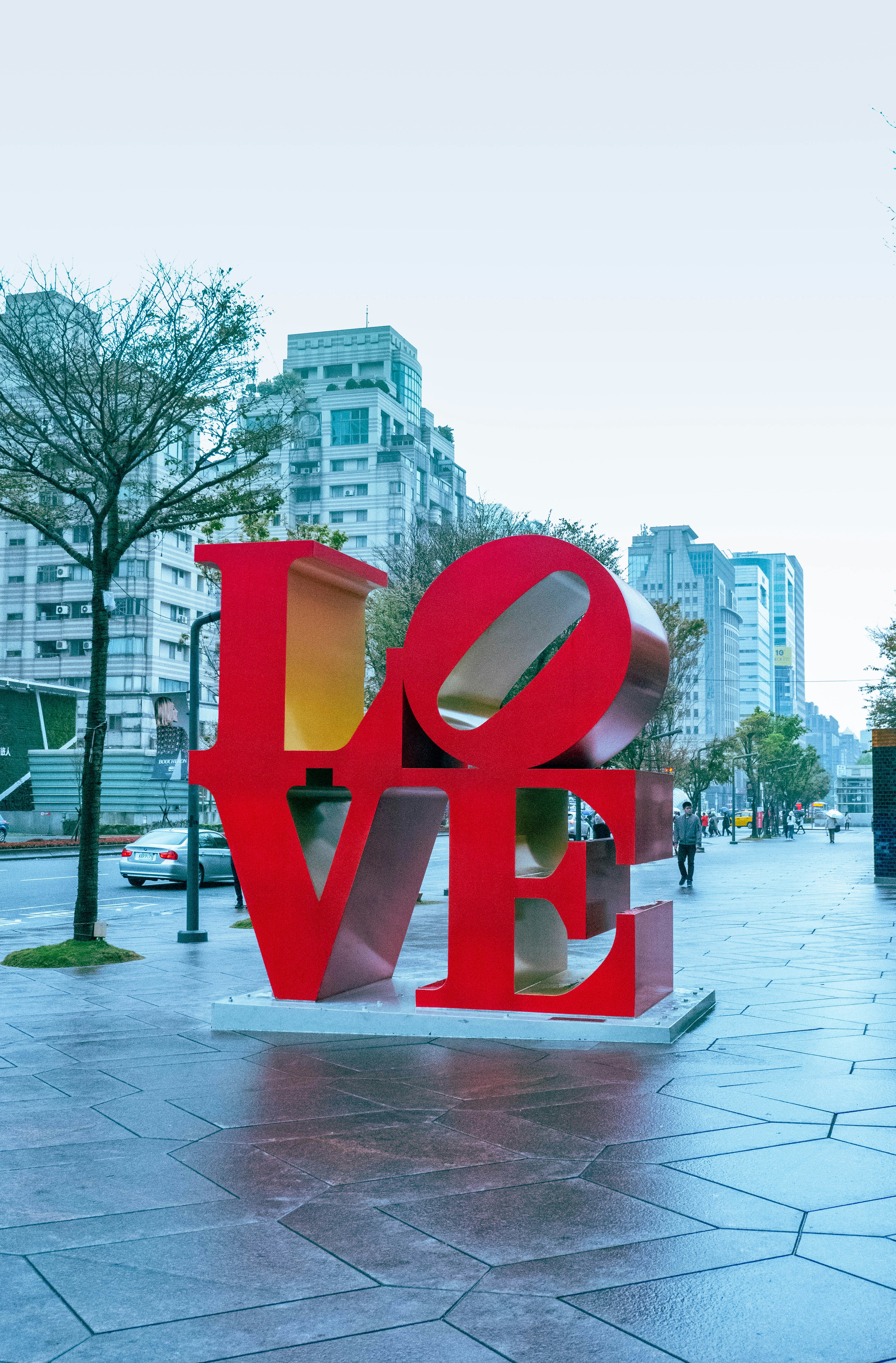 Large red love sculpture on city street