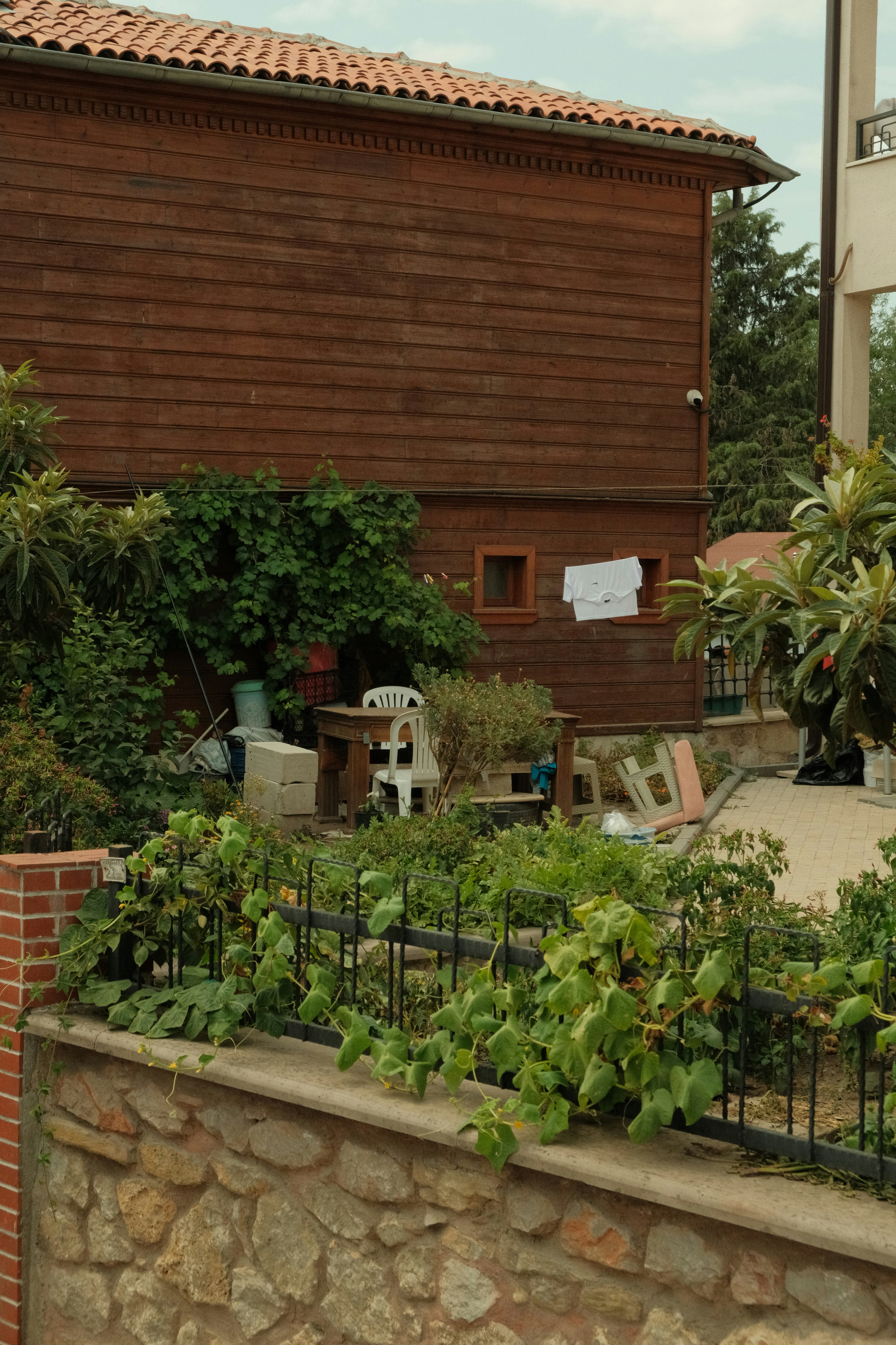 Wooden house with garden and stone wall