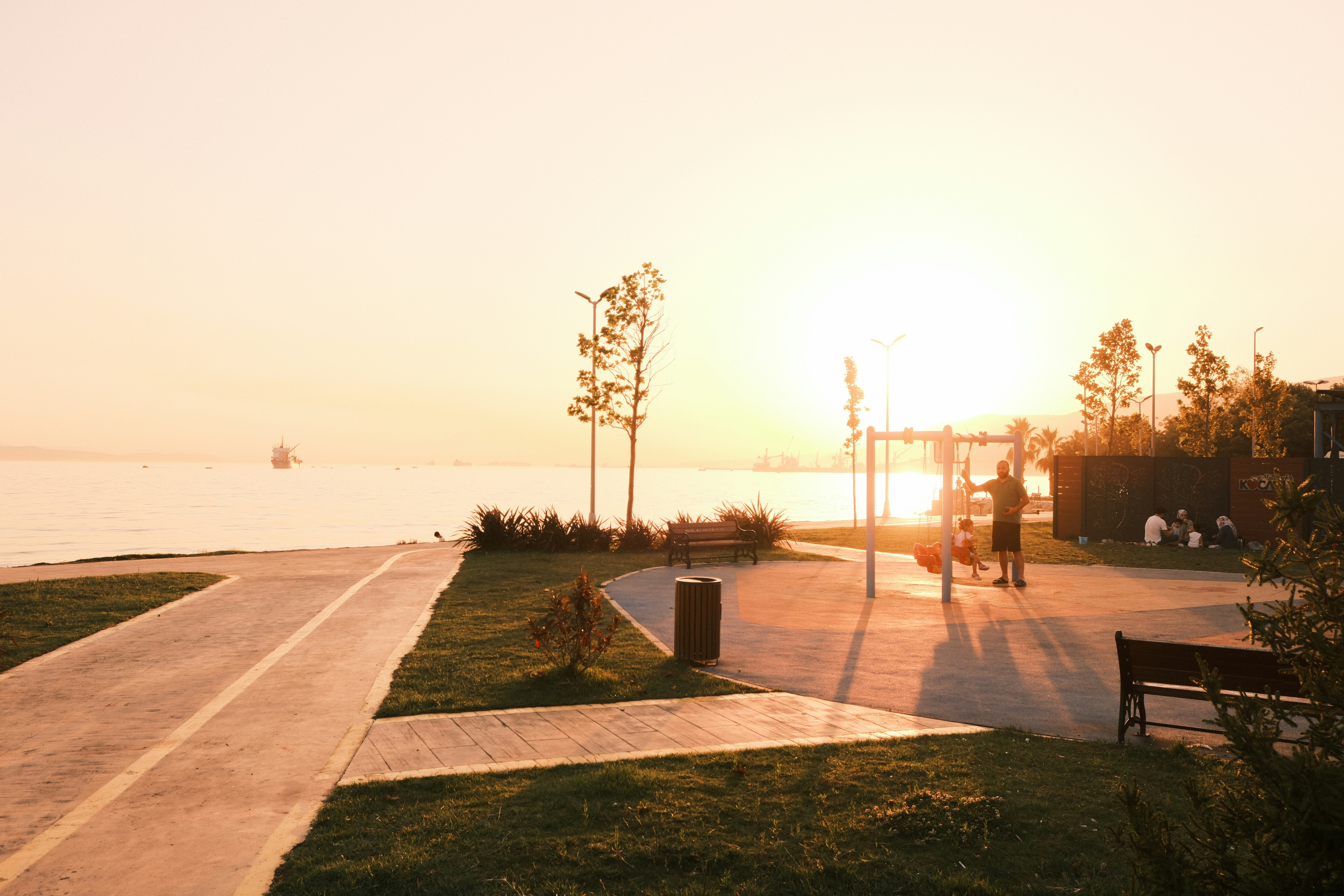 Sunset over a park with people exercising