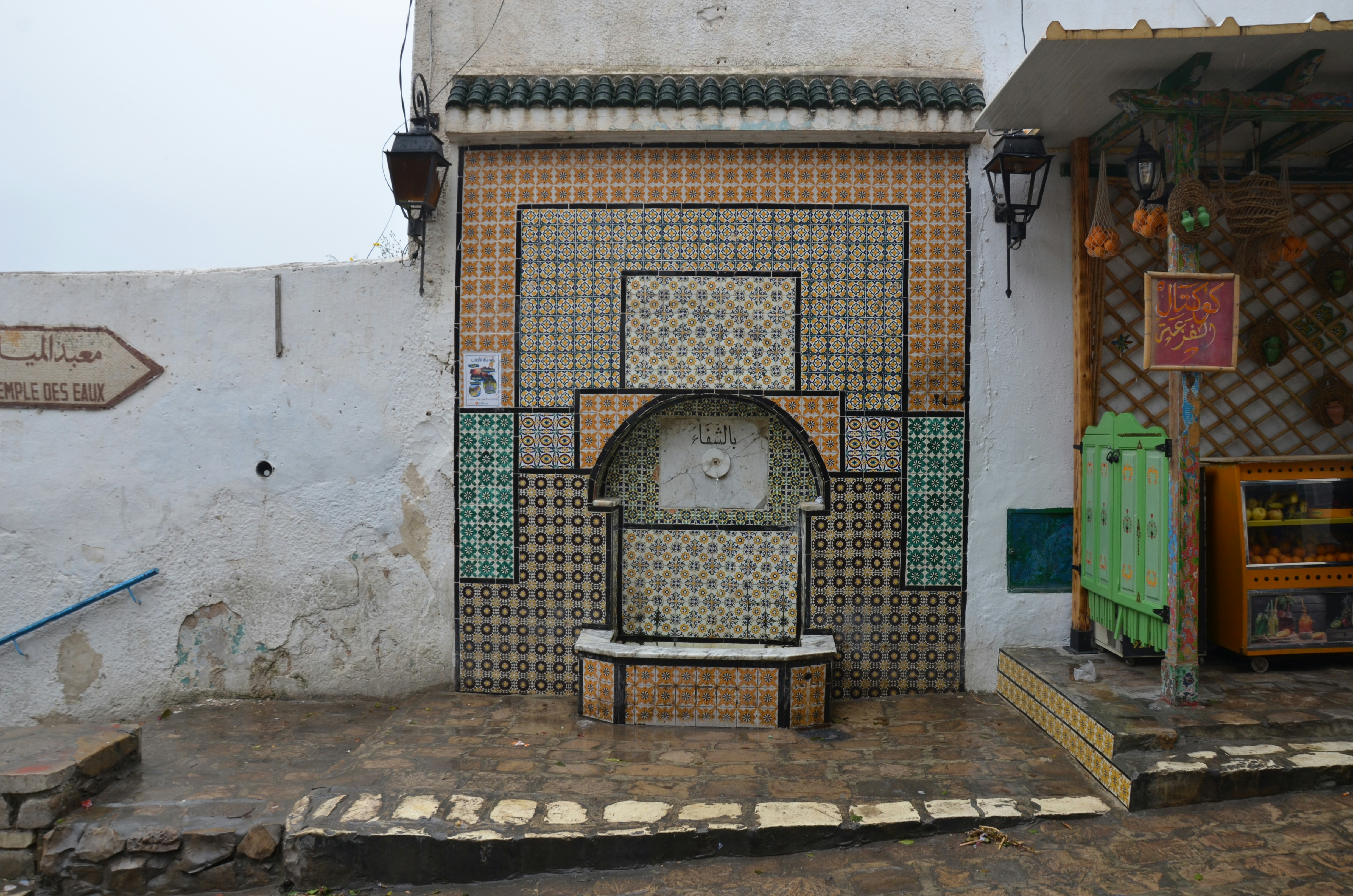 Geometric Oasis: The Mosaic Fountain in a Weathered Courtyard