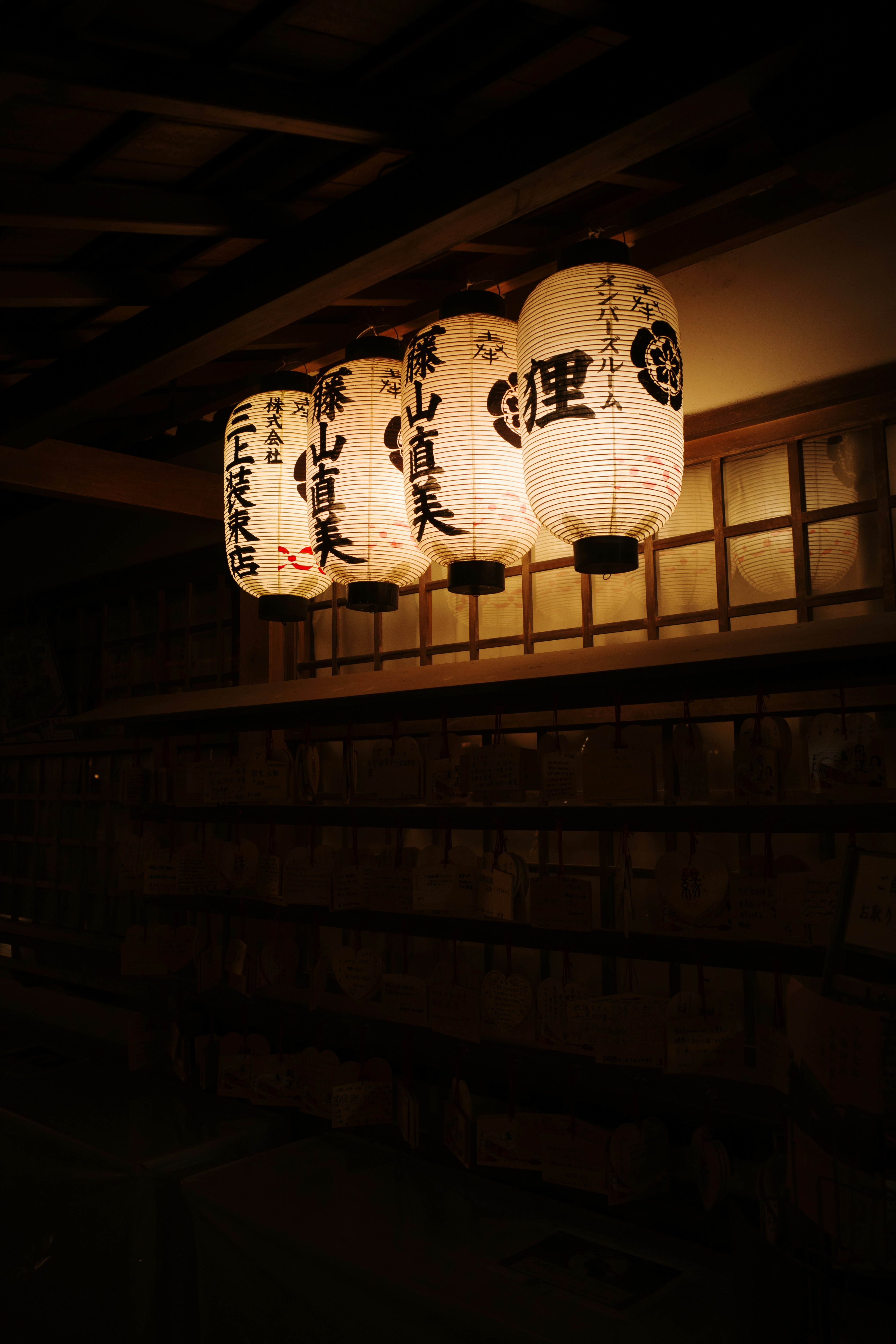 Four japanese lanterns hanging indoors at night. photo – Free Building ...