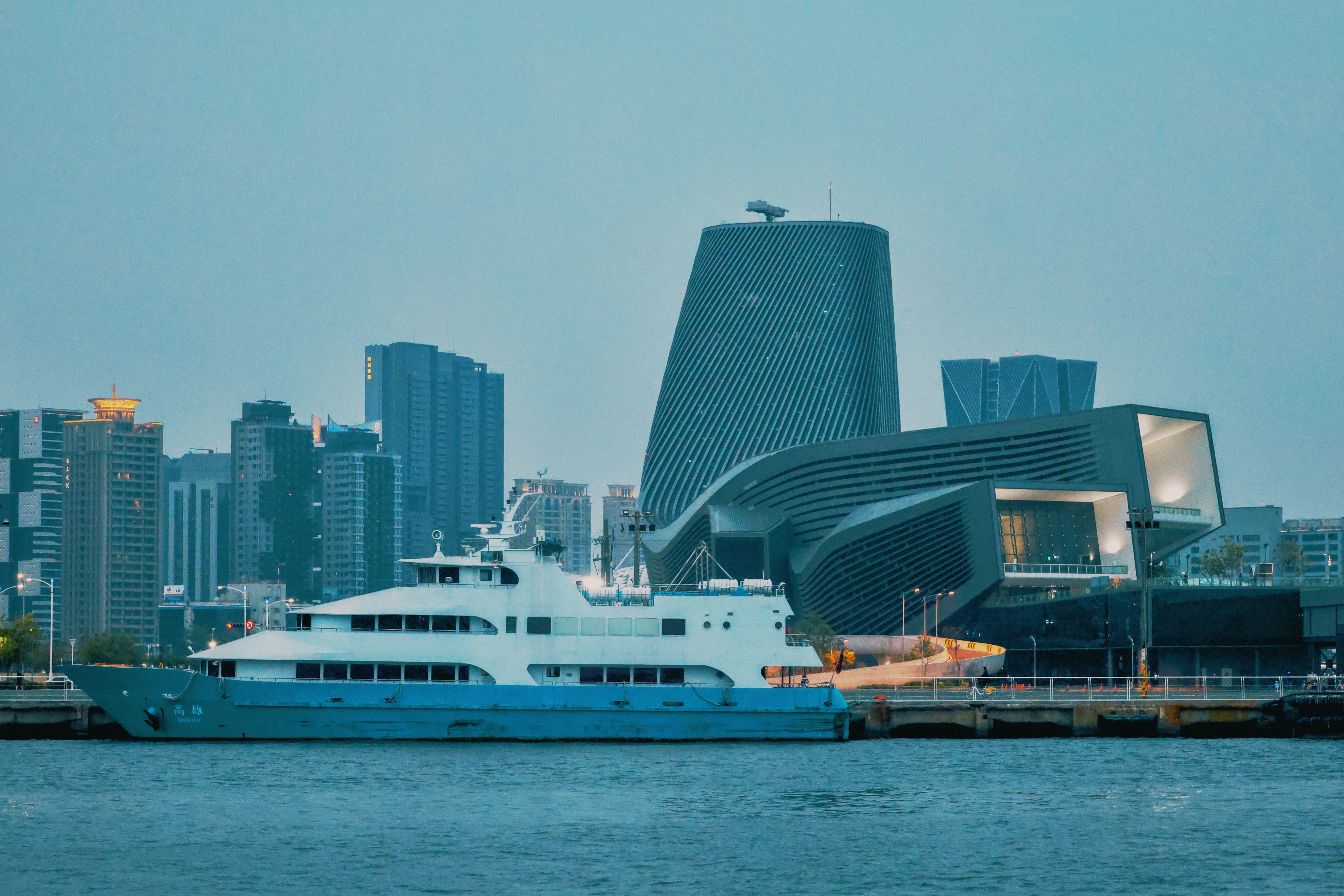 Harbor silhouette: a modern cityscape meets a sleek pier cruiser