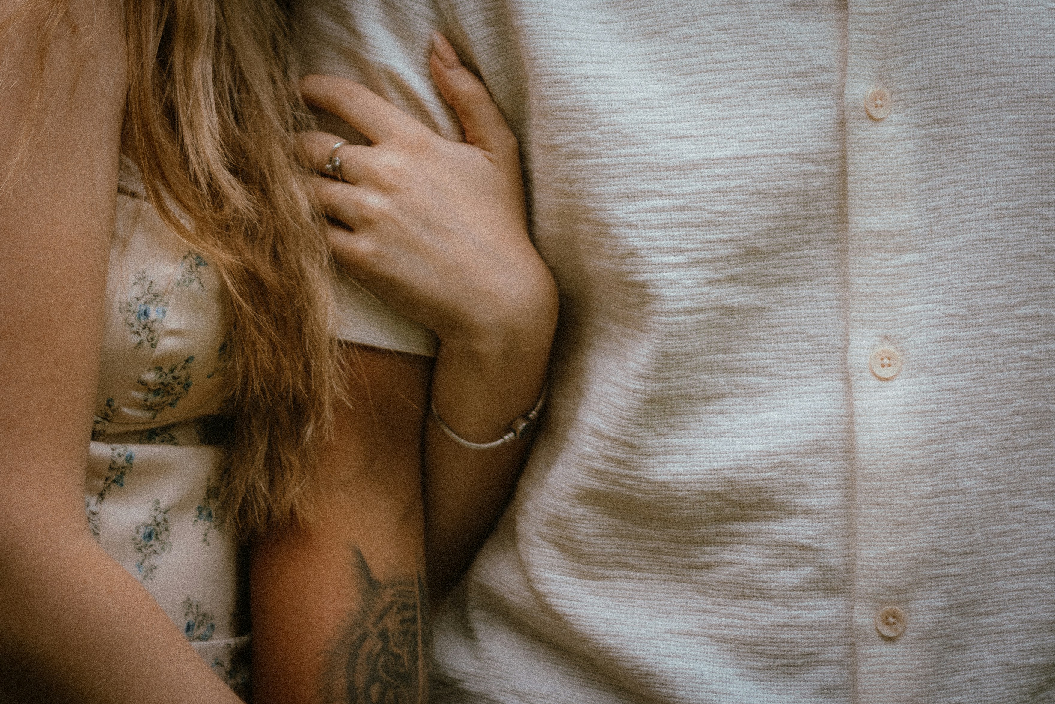 Couple embracing with hands touching