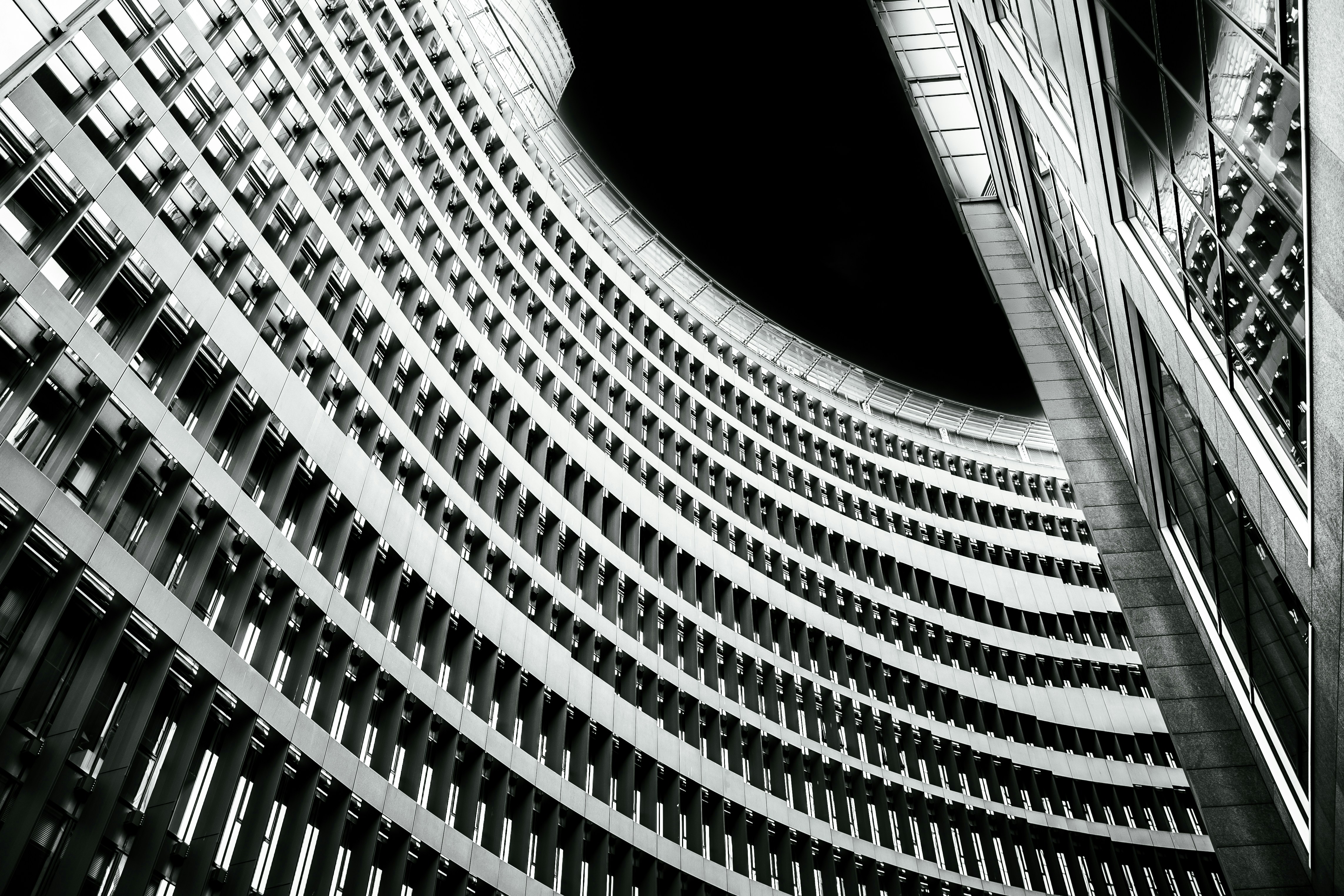 Curved modern building facade against dark sky photo – Free ...