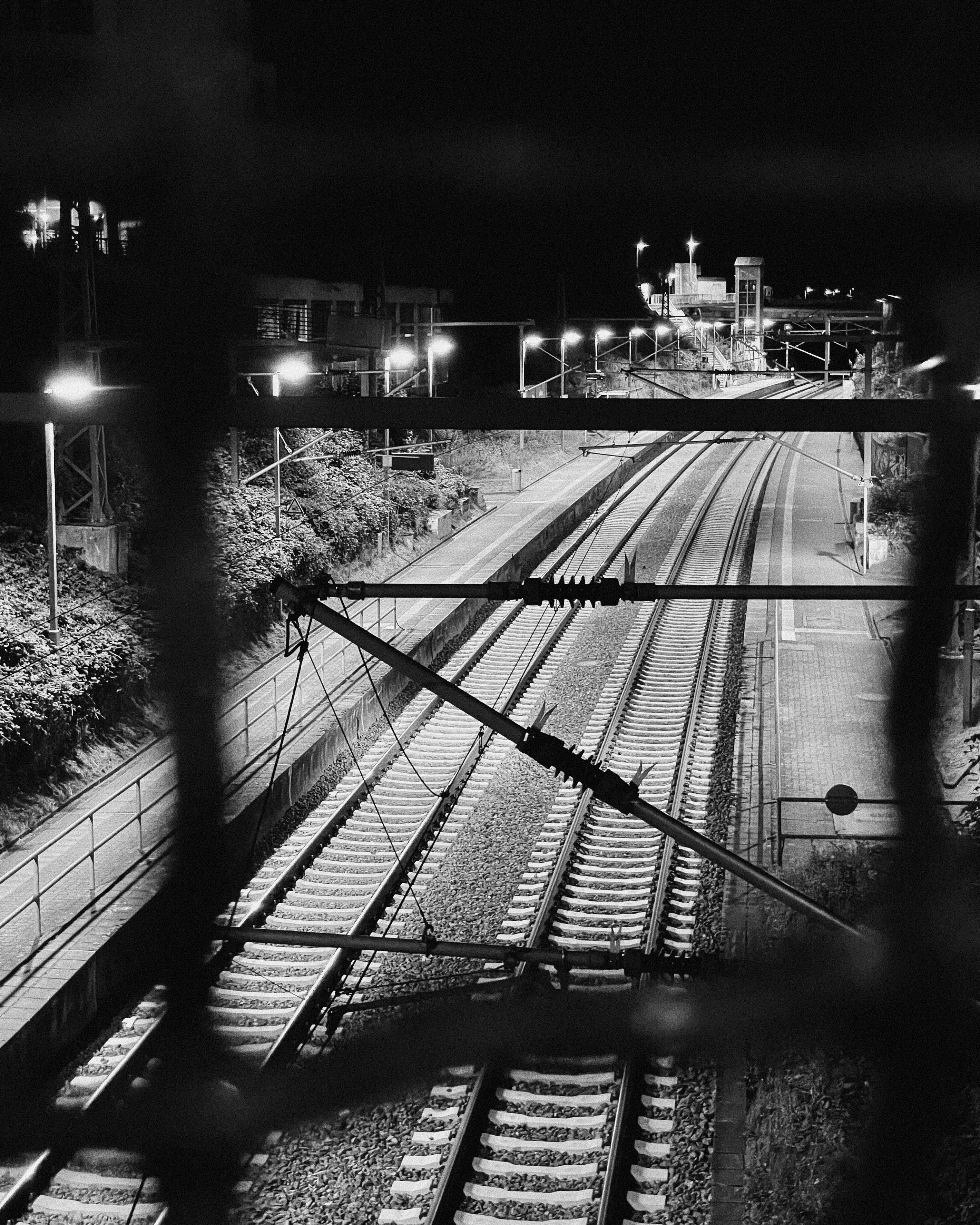 Train tracks at night with distant lights