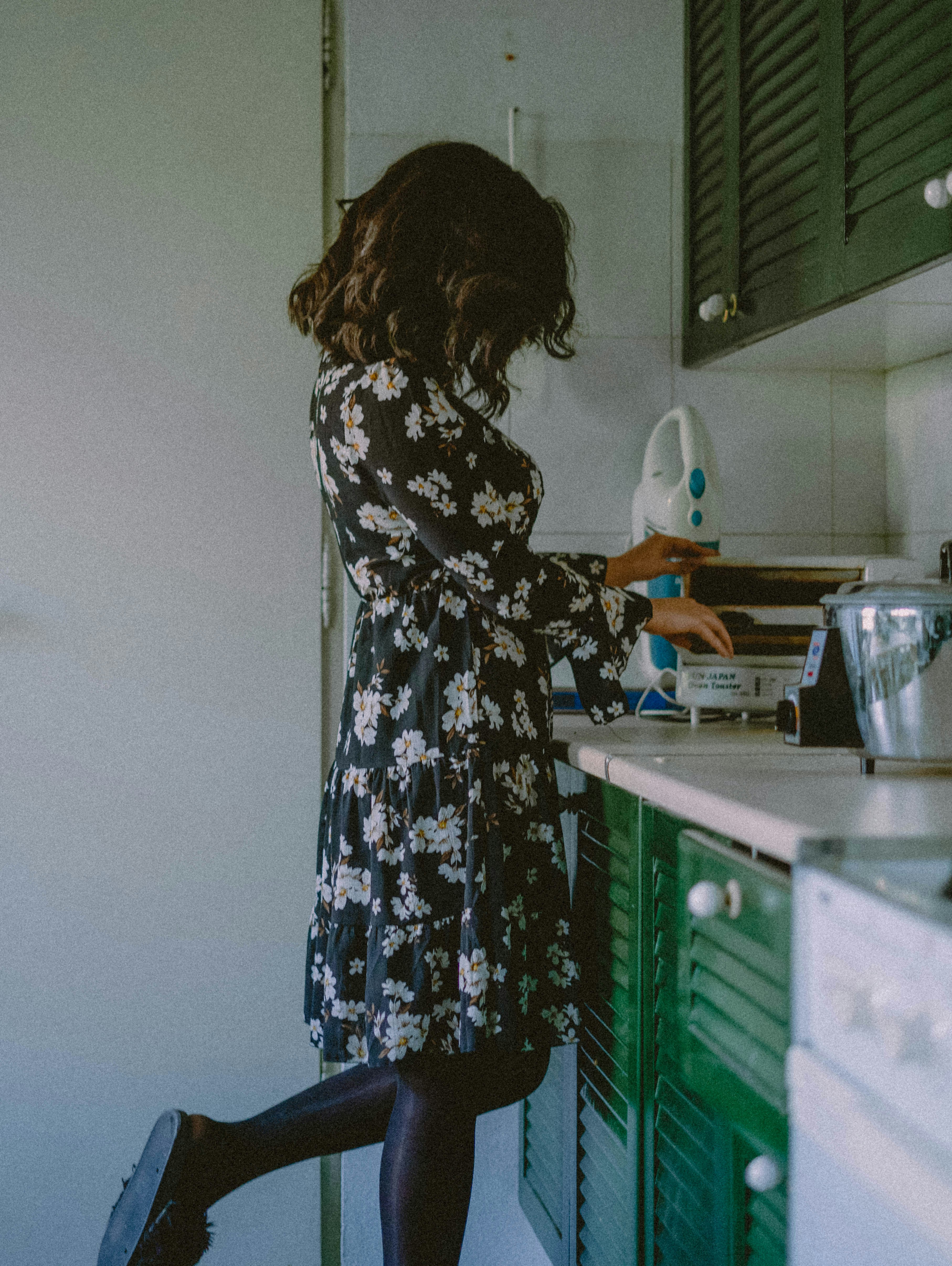 Woman in floral dress in a kitchen photo – Free Image on Unsplash
