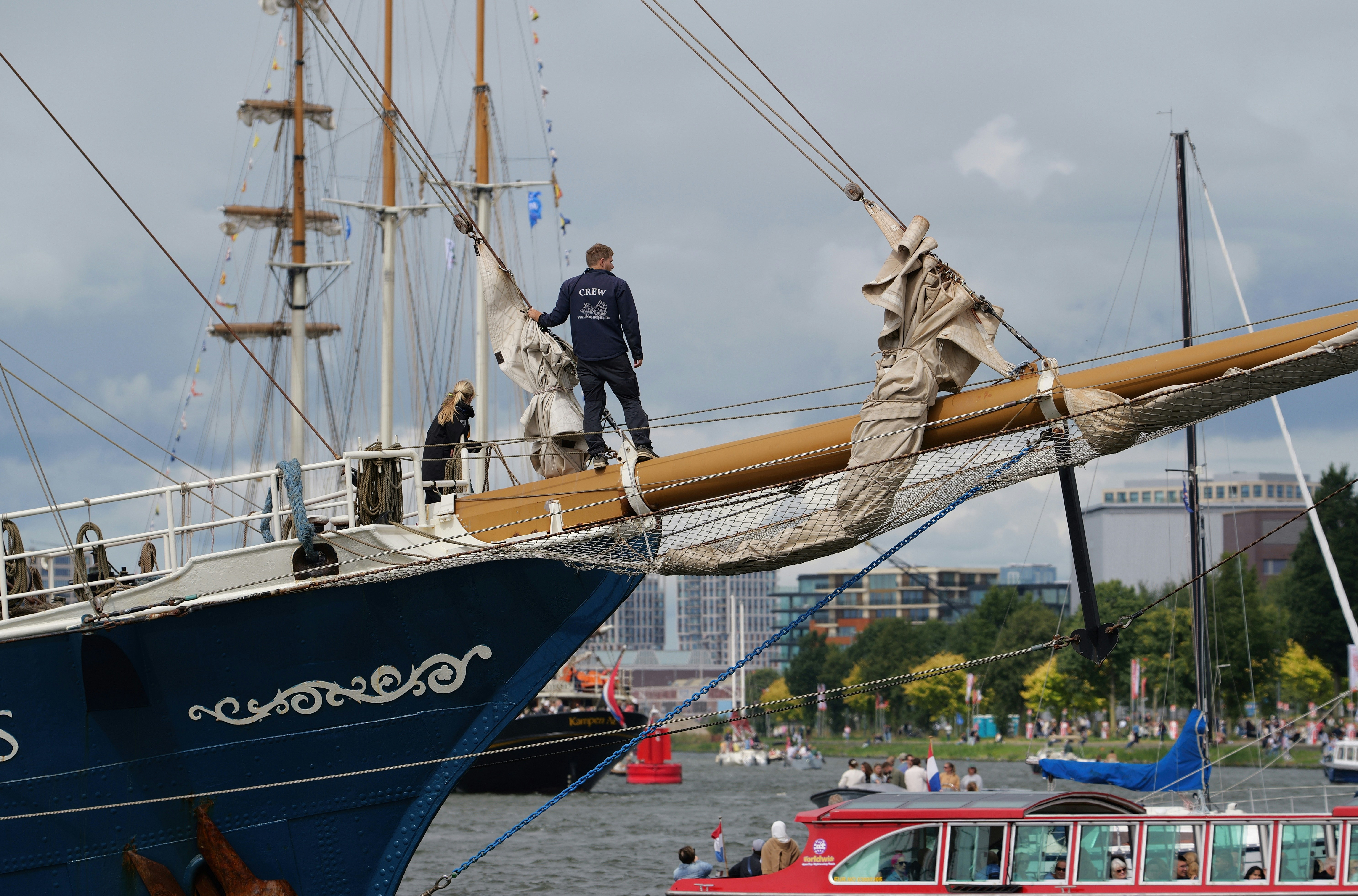 Riggers at the Bow: Crew Climb the Yard-Length Mast on a Classic Sailing Vessel