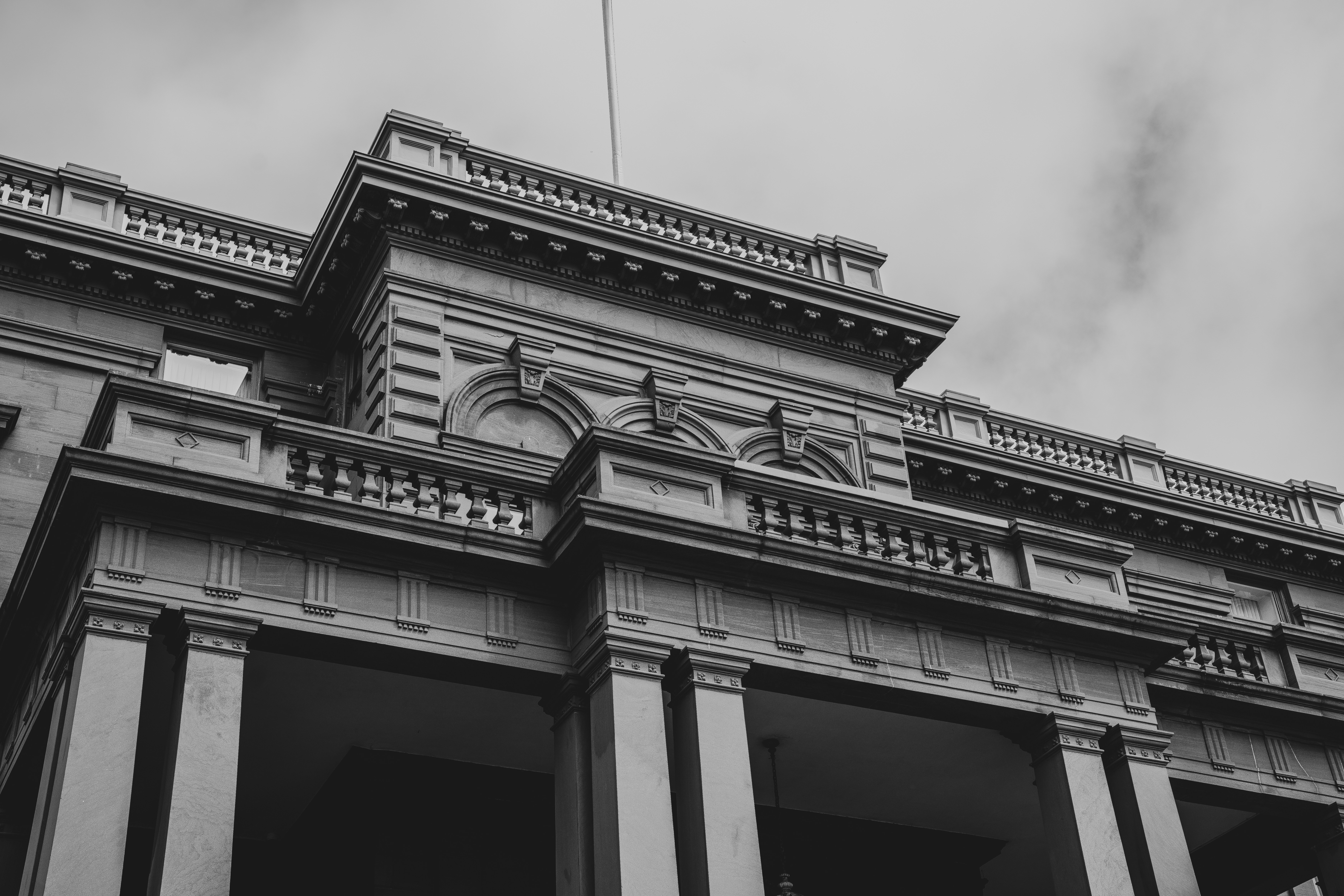 Detailed view of a historic building's façade showcasing intricate architectural elements in monochrome.