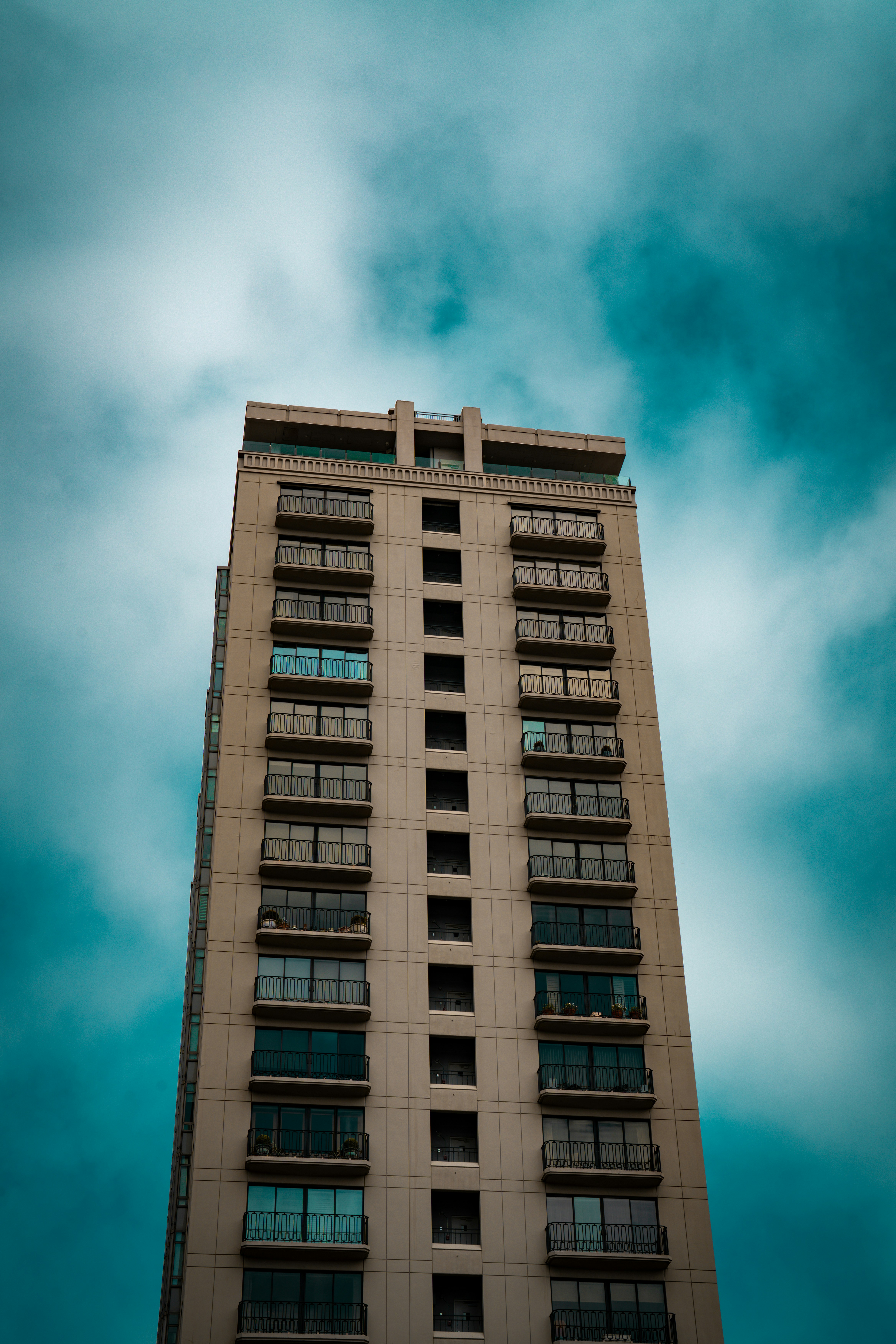 Tall apartment building against a cloudy sky