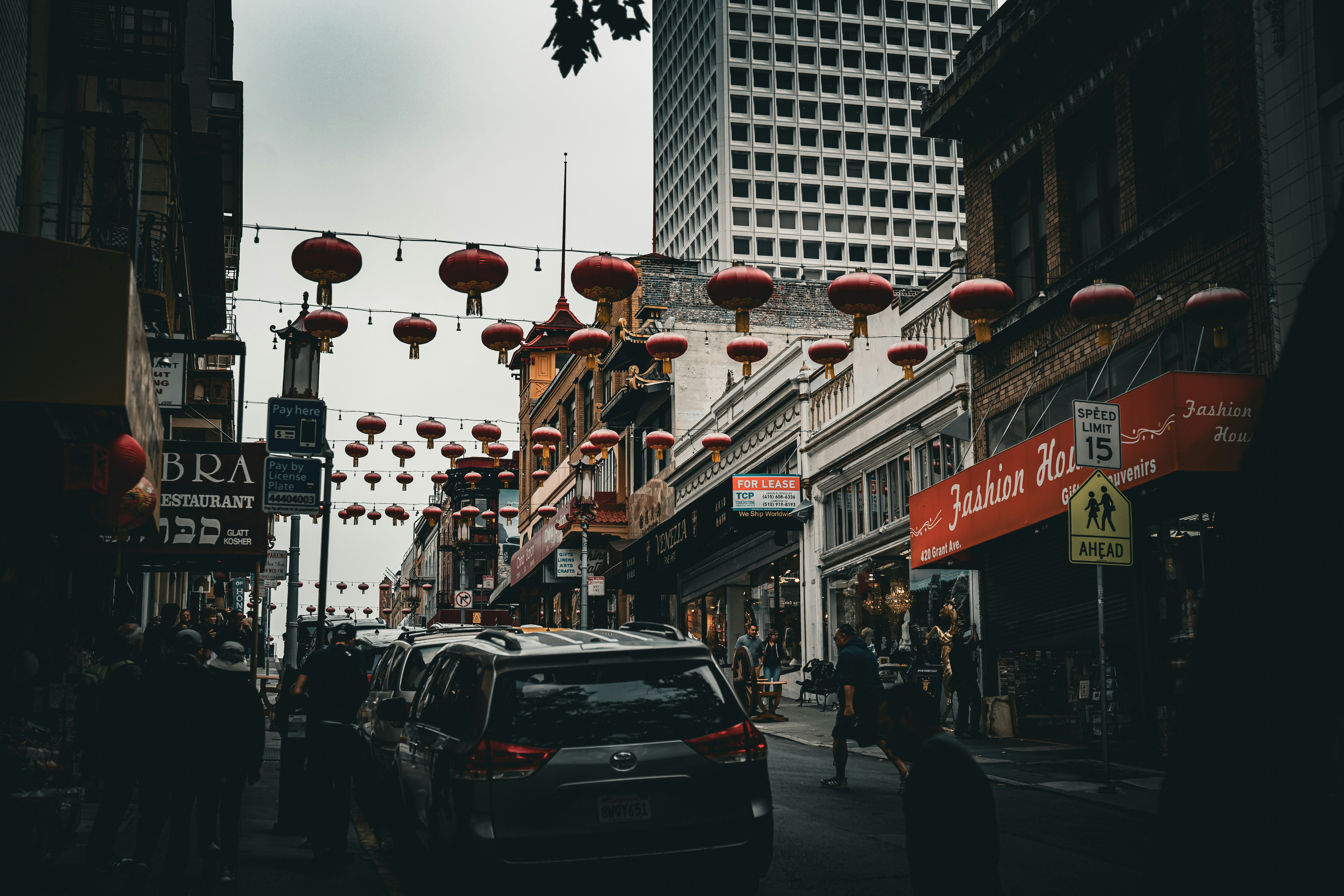 Red lanterns strung across a city street