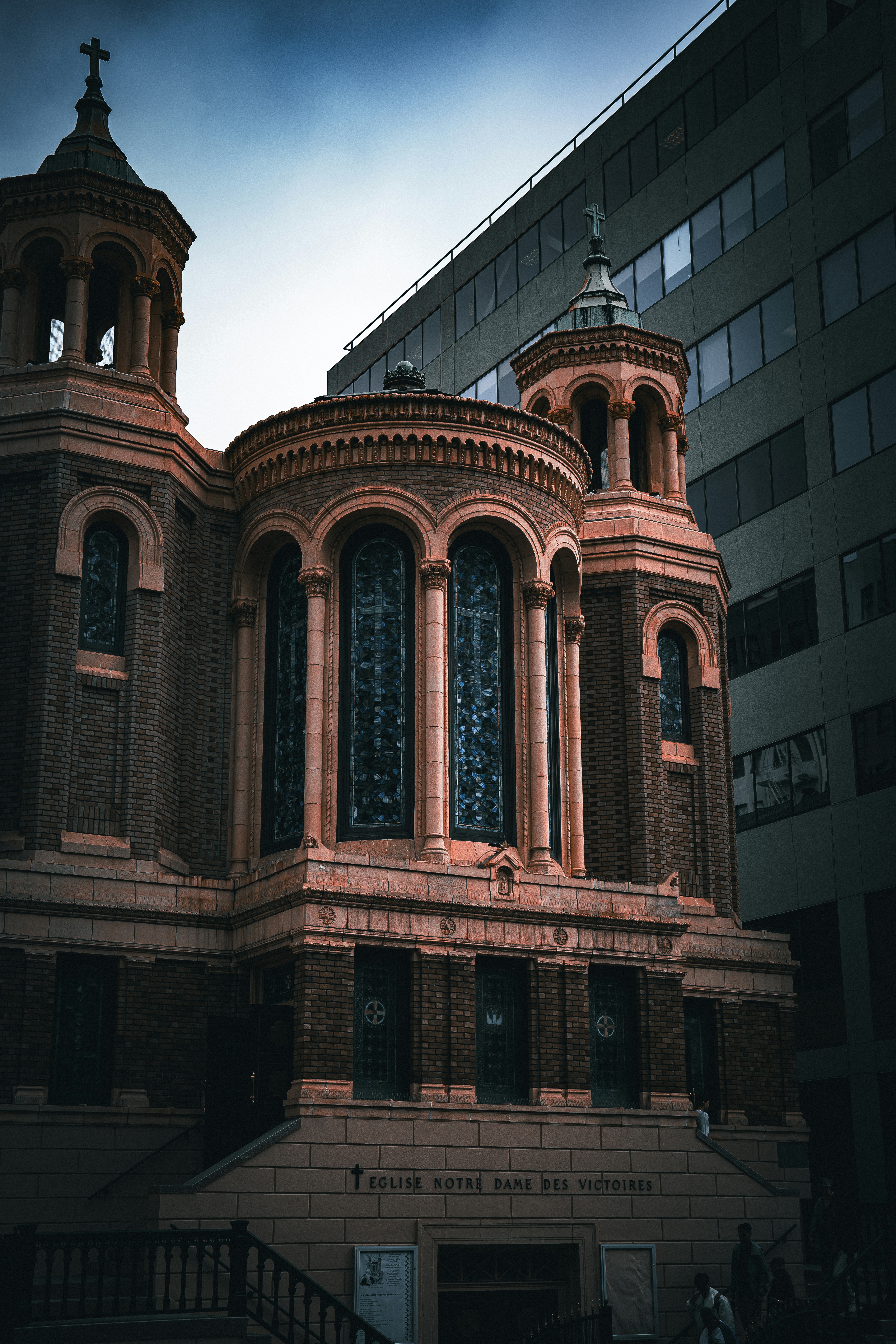 Ornate church with stained glass windows next to modern building