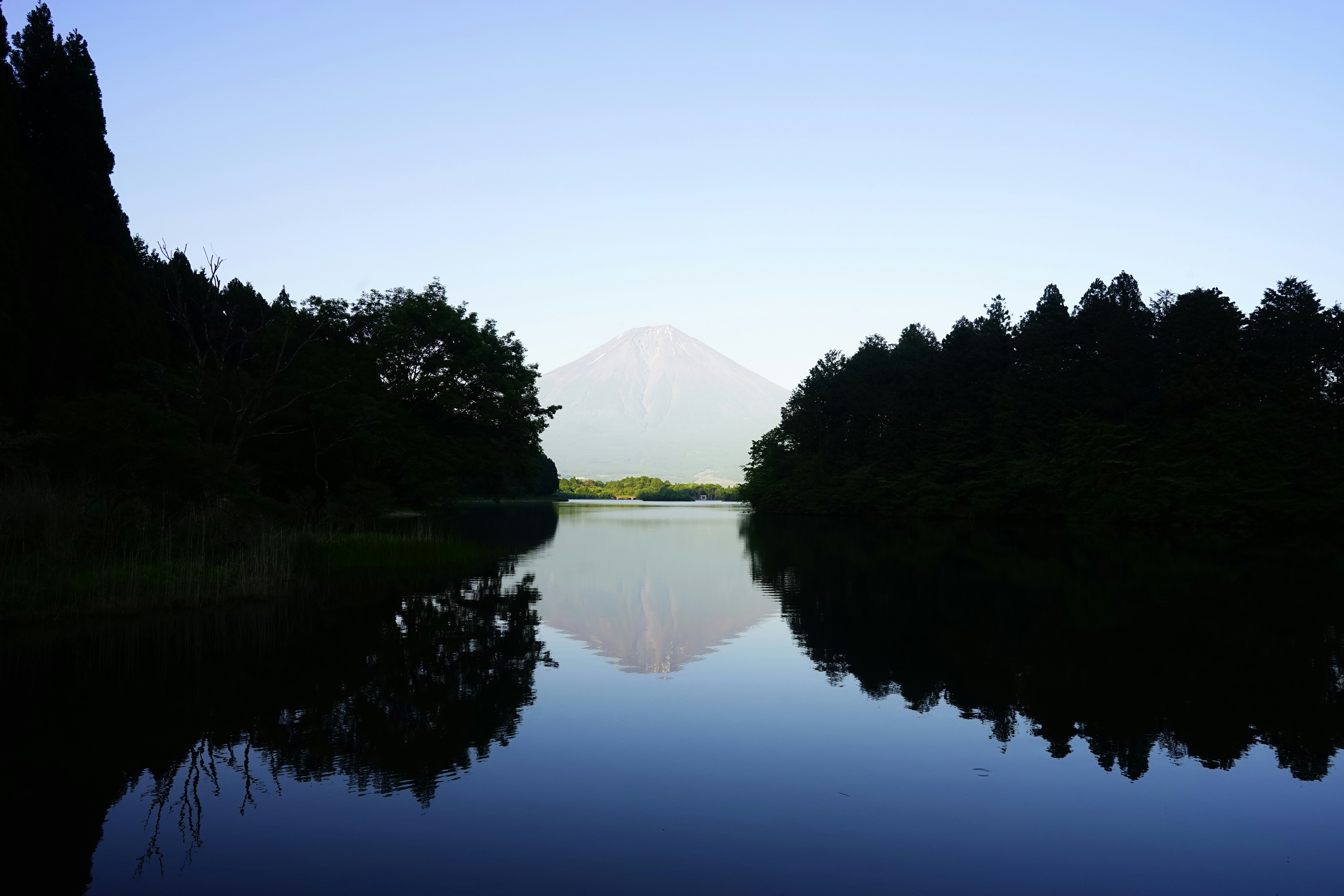 Mount fuji reflected in a calm lake at dawn