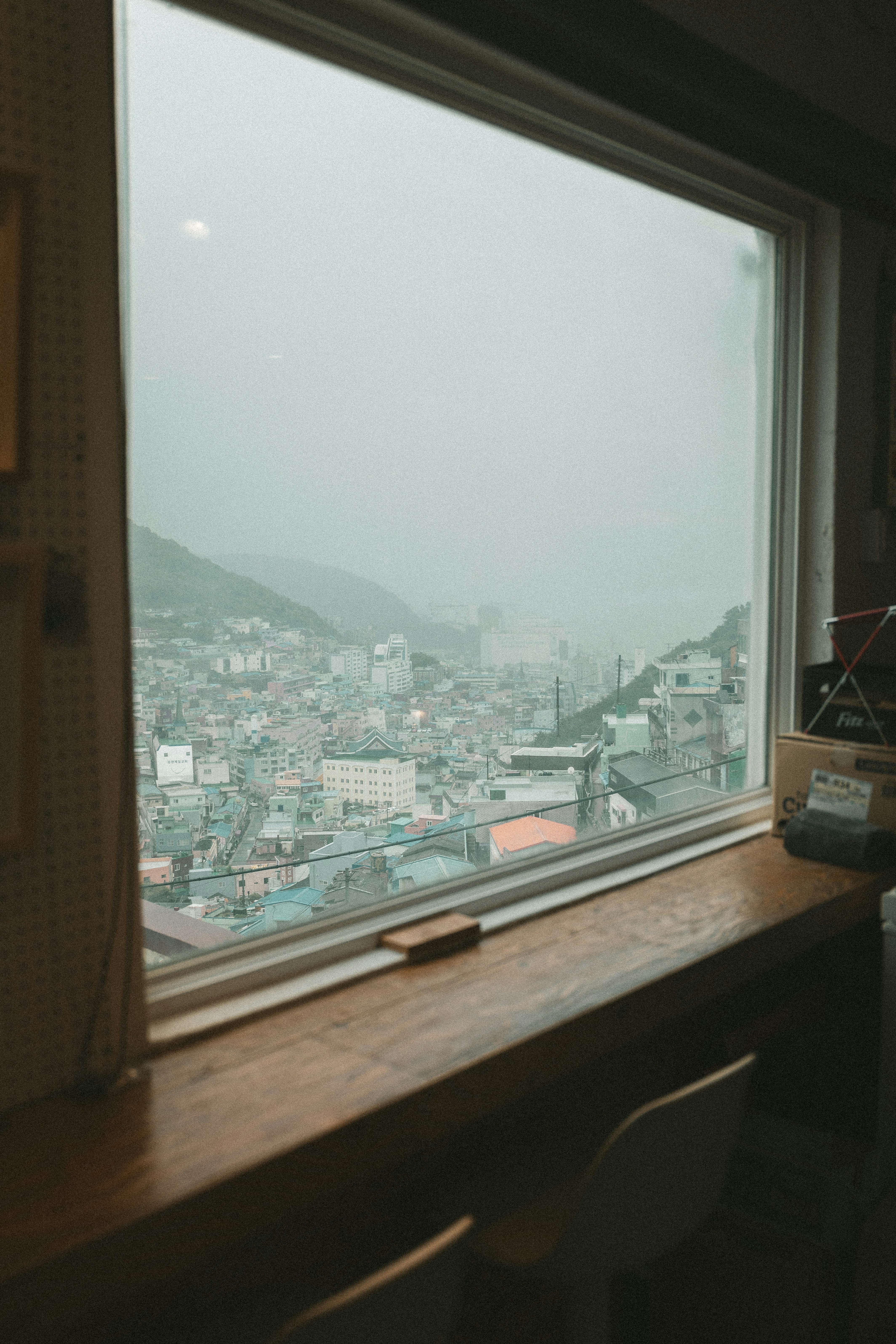 Rainy city view through a large window