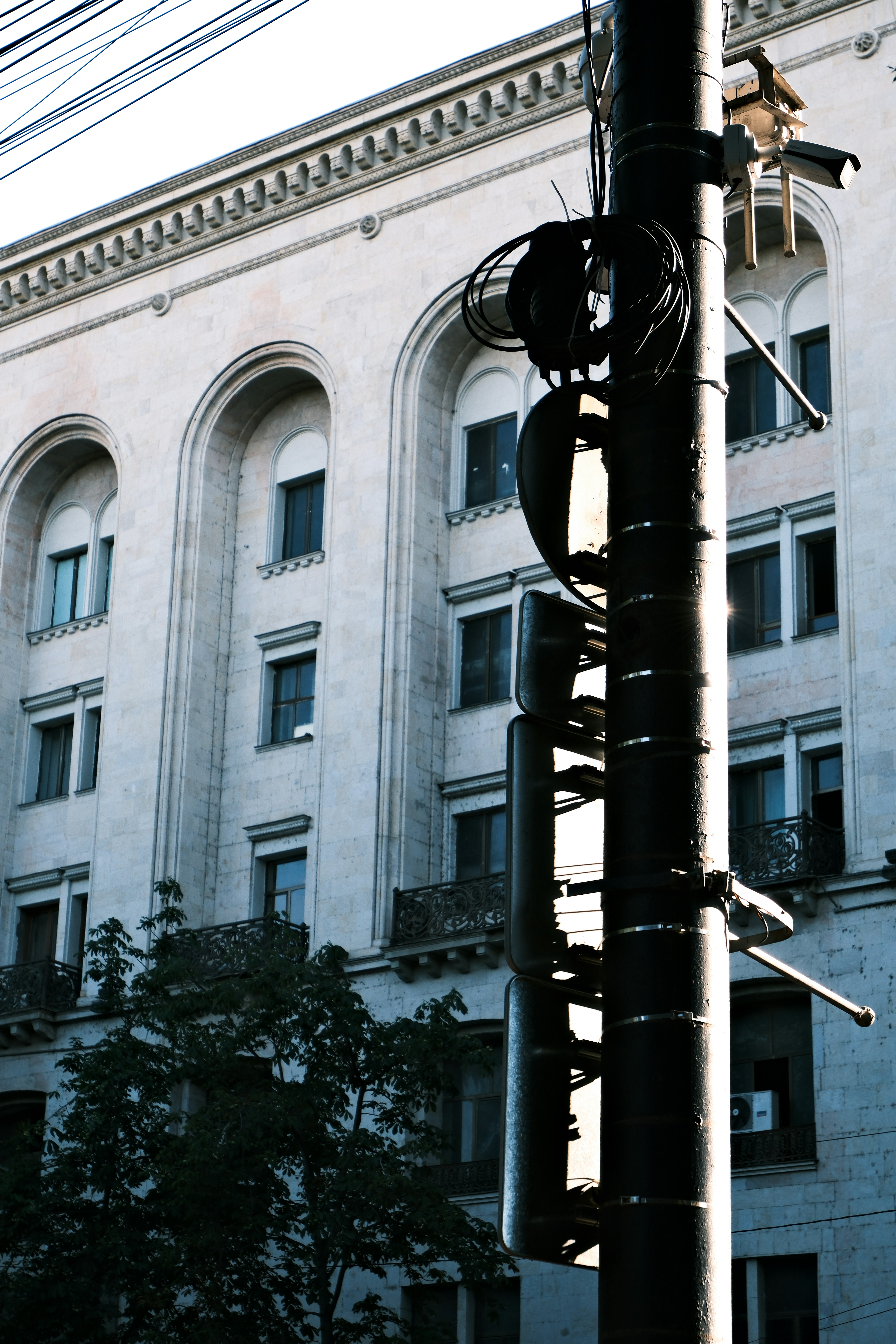 Wired Monolith Against a Neoclassical Facade