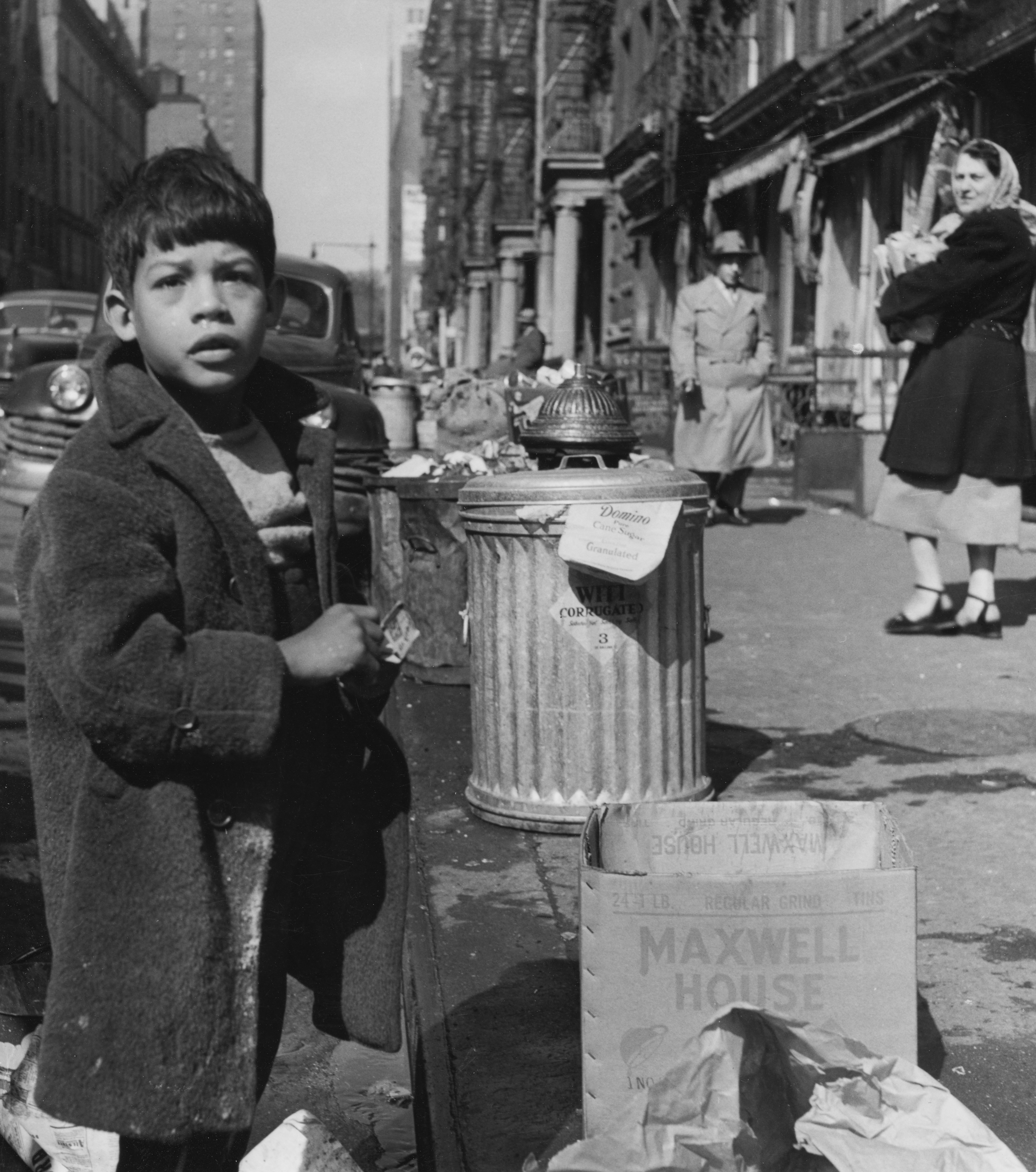 Schomburg Center for Research in Black Culture, Photographs and Prints Division, The New York Public Library. "Street scene with young boy and passersby" The New York Public Library Digital Collections. 1947 - 1951. https://digitalcollections.nypl.org/items/09494020-f5c5-013c-e1d7-0242ac110004