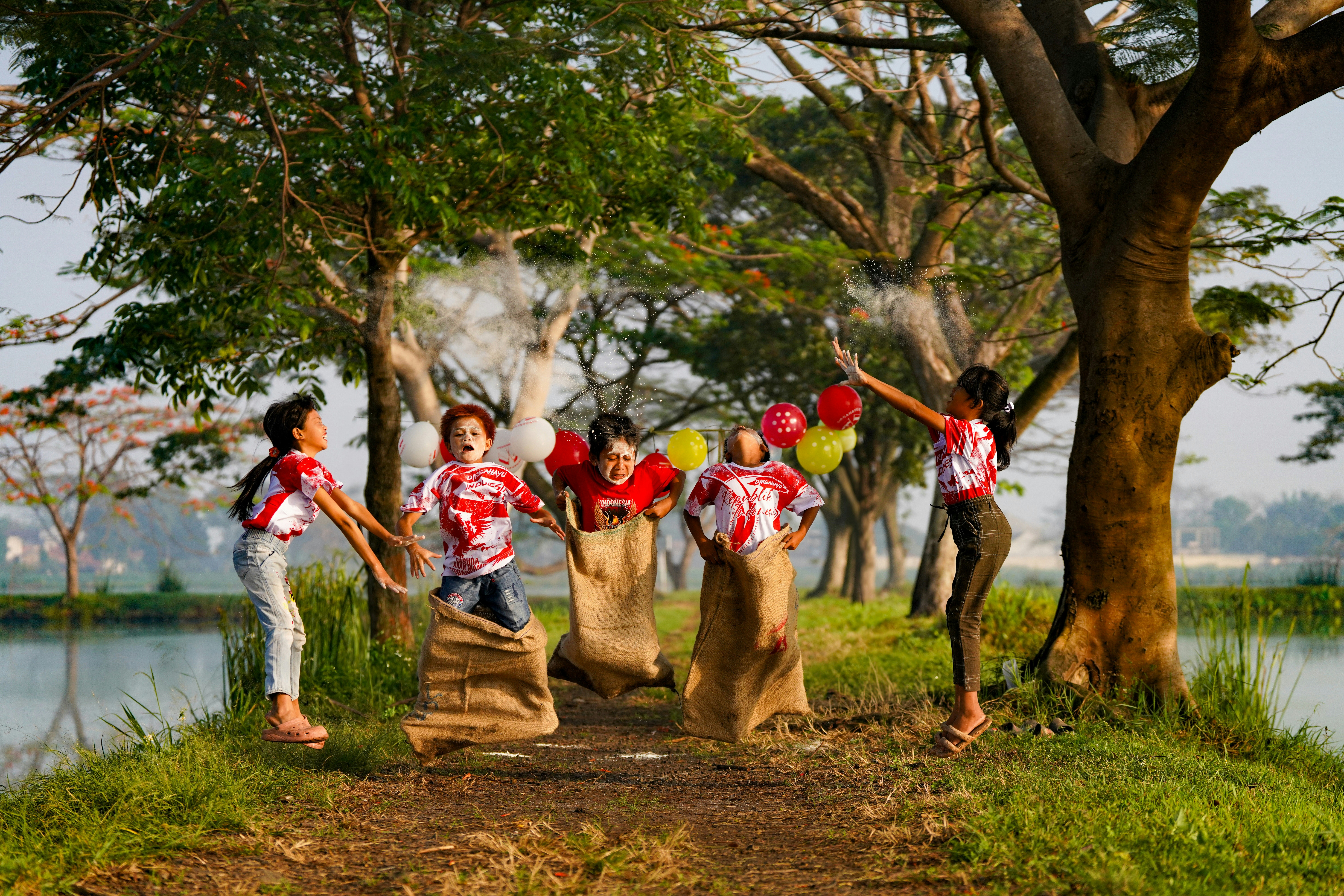 Children jumping in burlap sacks during a race outdoors photo – Free ...