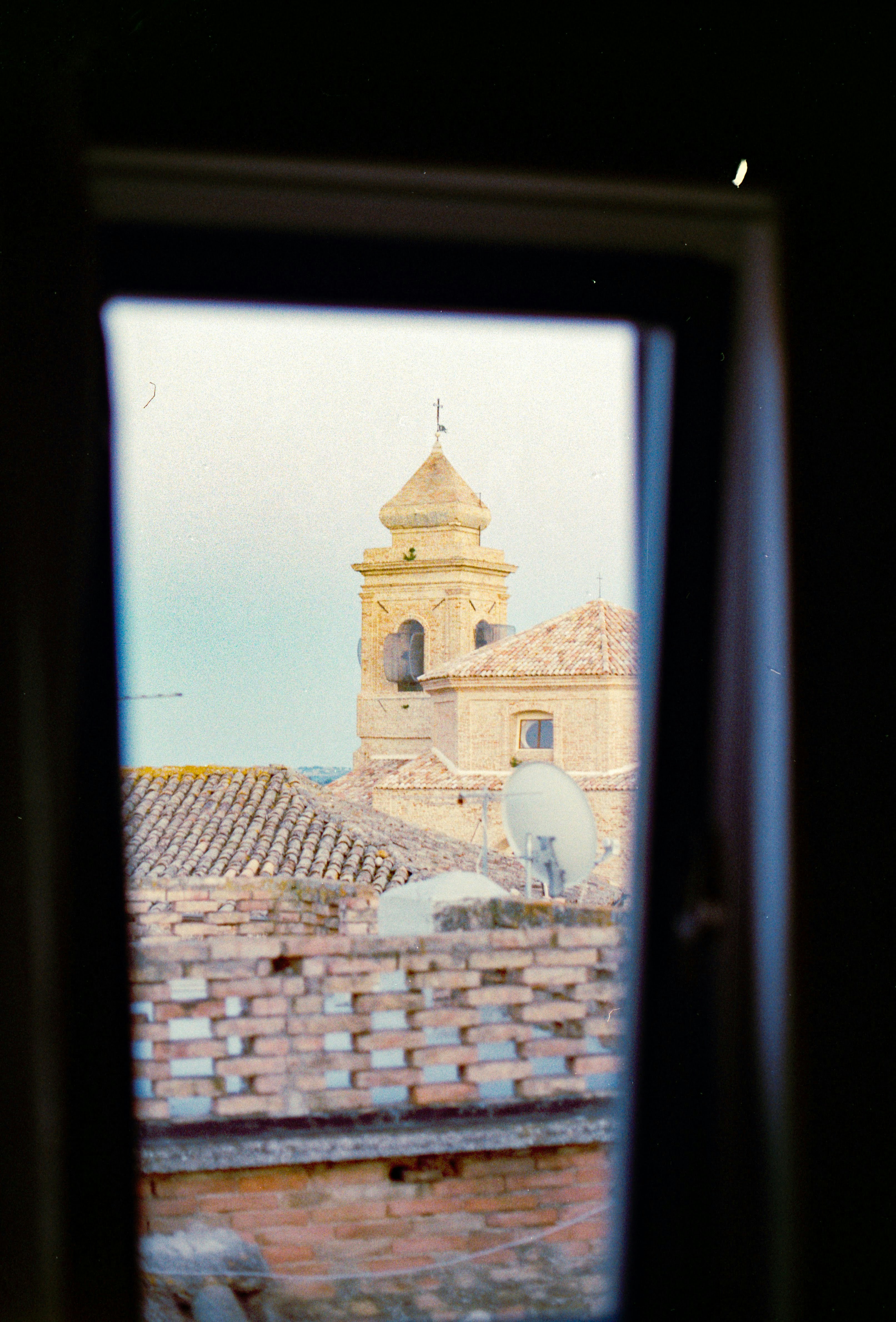 View of church tower through a window frame photo – Free Film ...