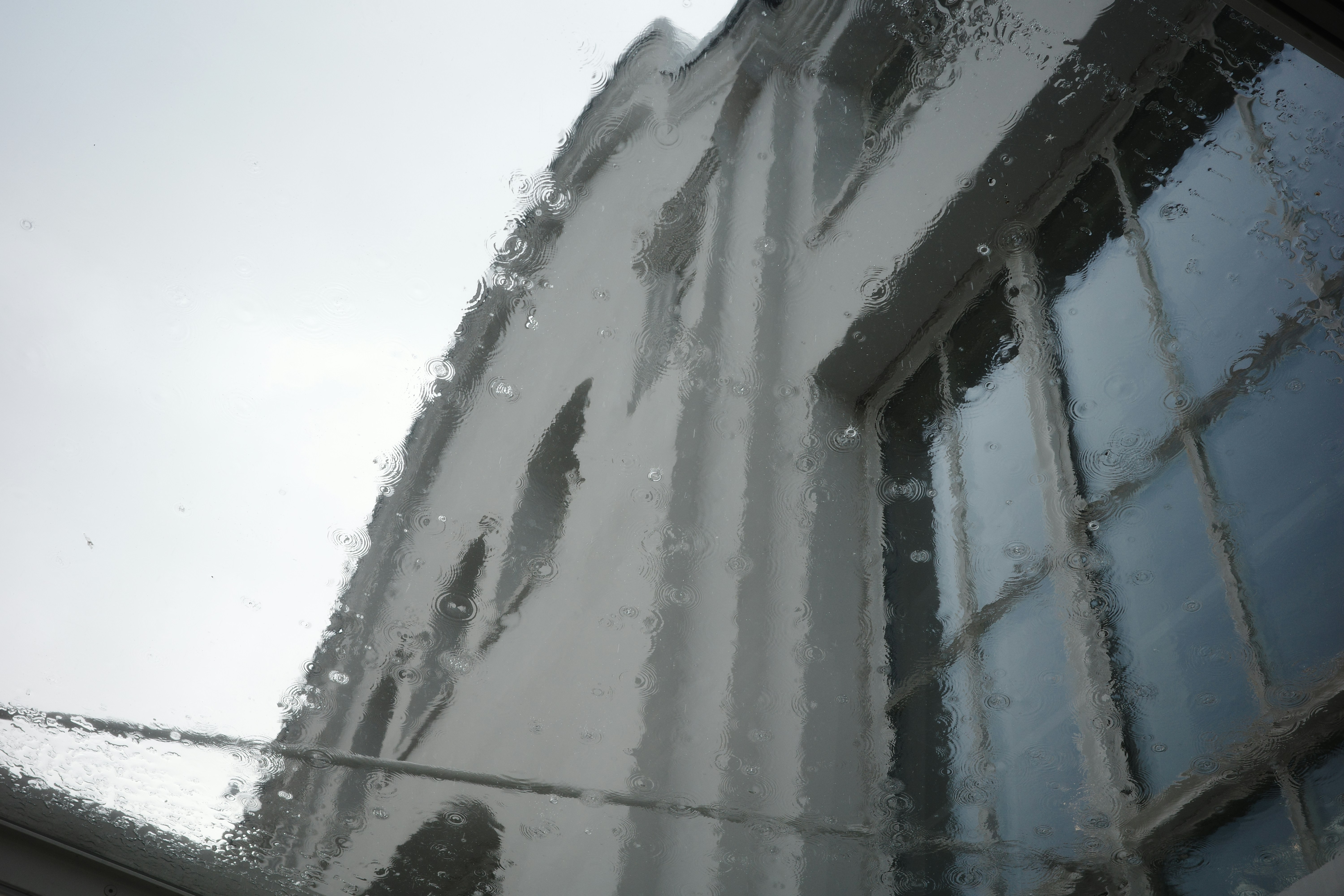 White building with large windows on a cloudy day