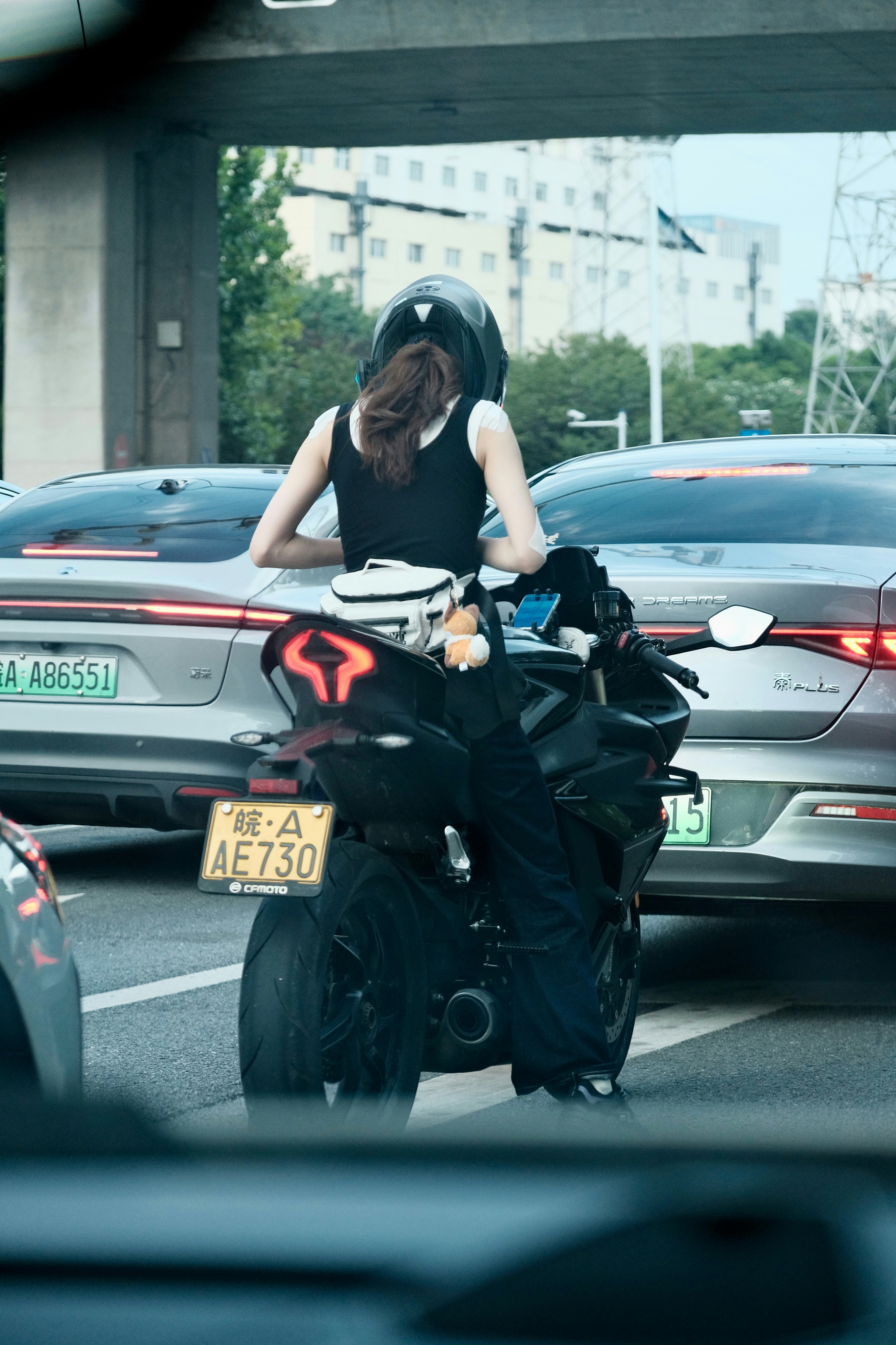 Woman on motorcycle in traffic