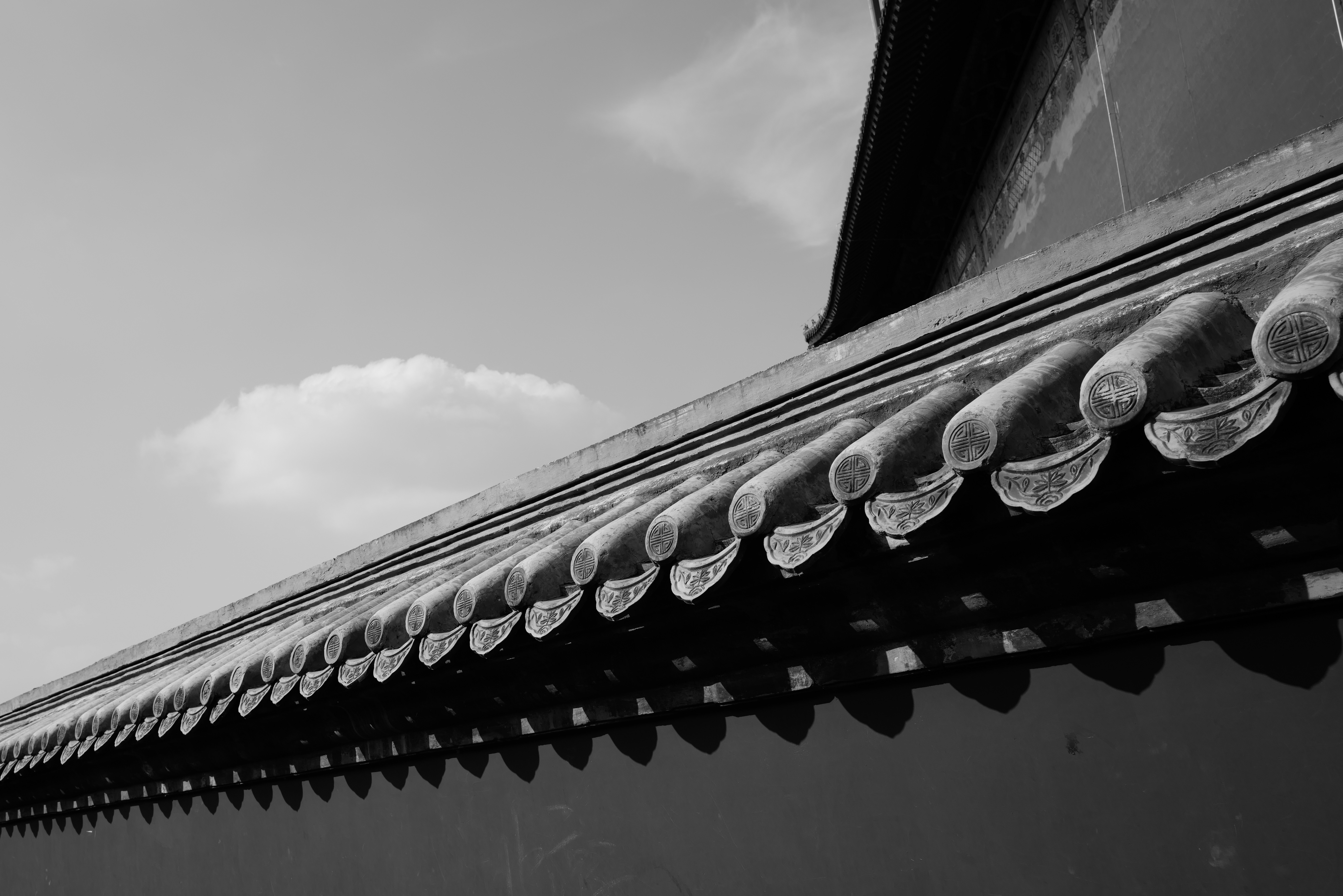 Beijing Bell Tower | Traditional tiled roof against a cloudy sky