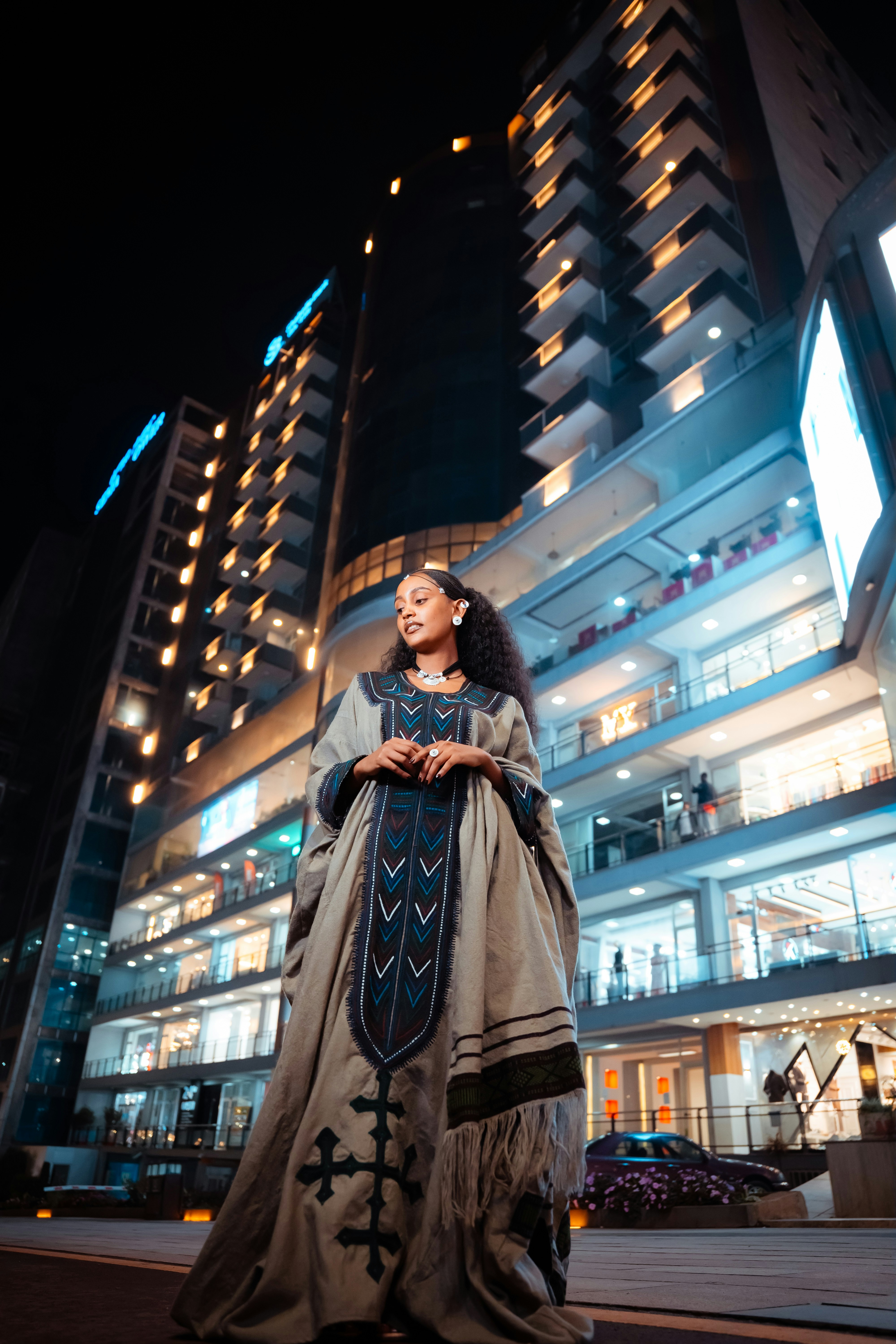 Miss Ashenda 2025 | Woman in traditional dress in modern city at night