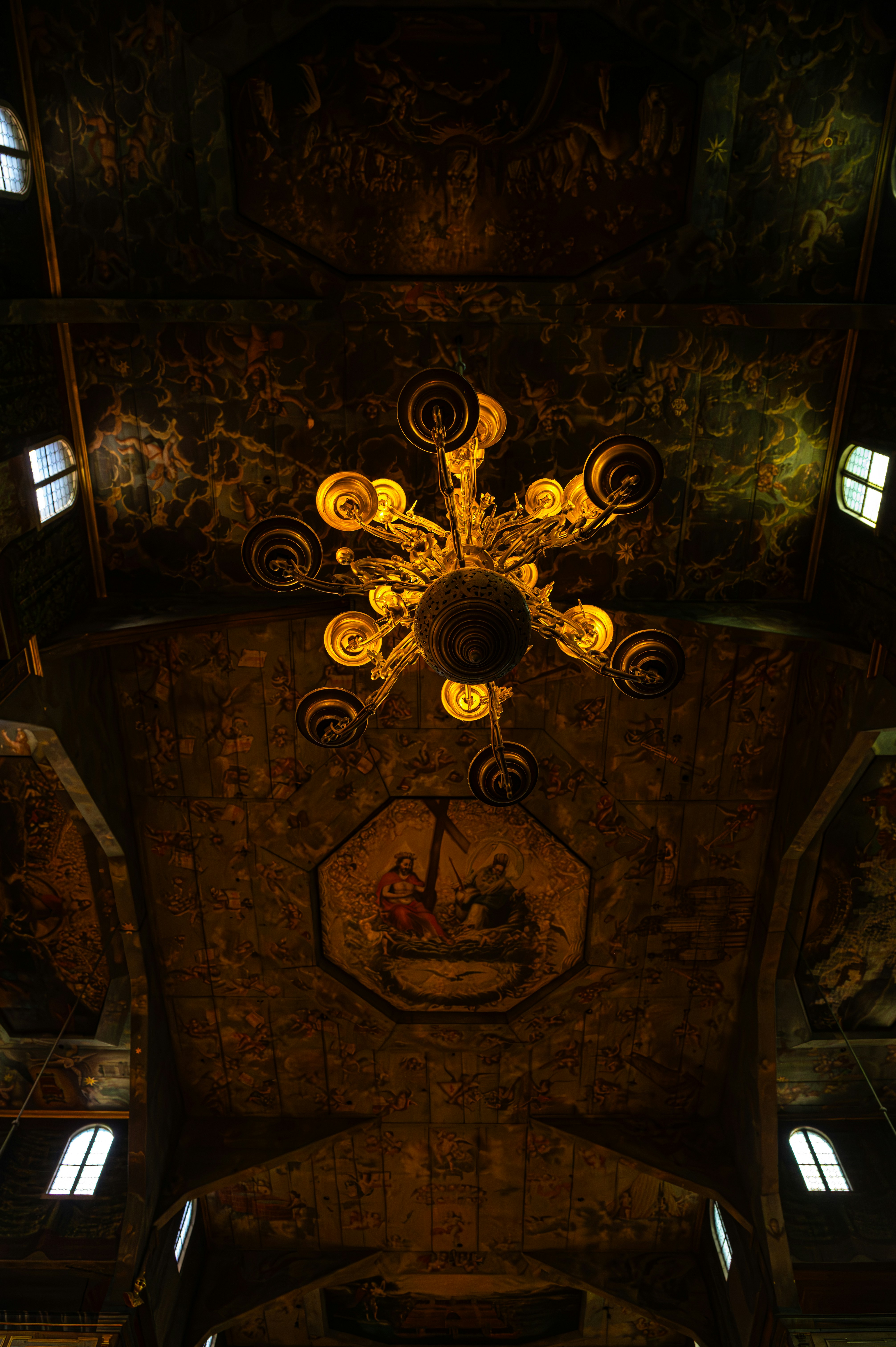 Gilded Orbit: Chandelier Cradled by a Baroque Ceiling