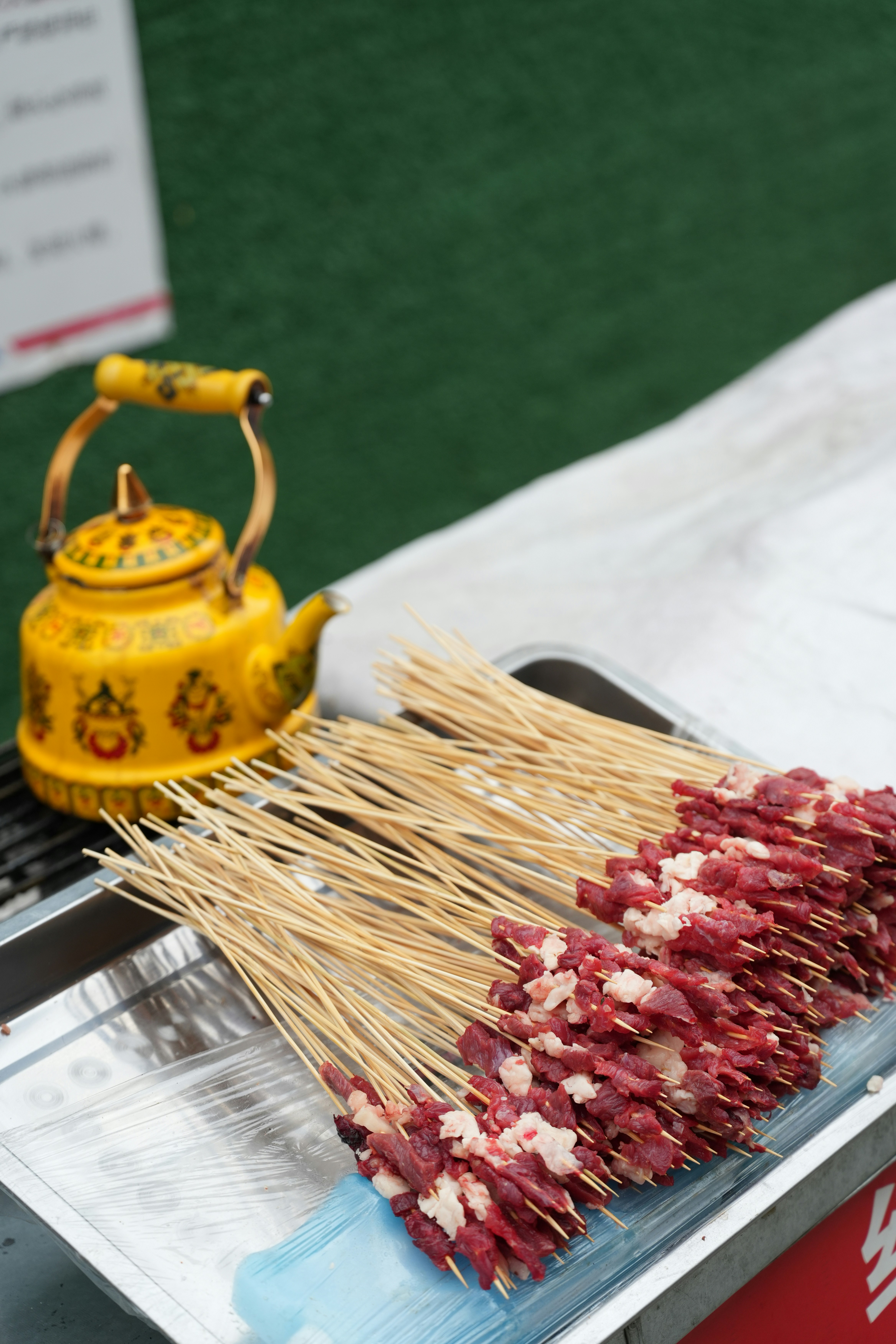 Skewers in Focus, Teapot in Frame: Street-Grill Portrait