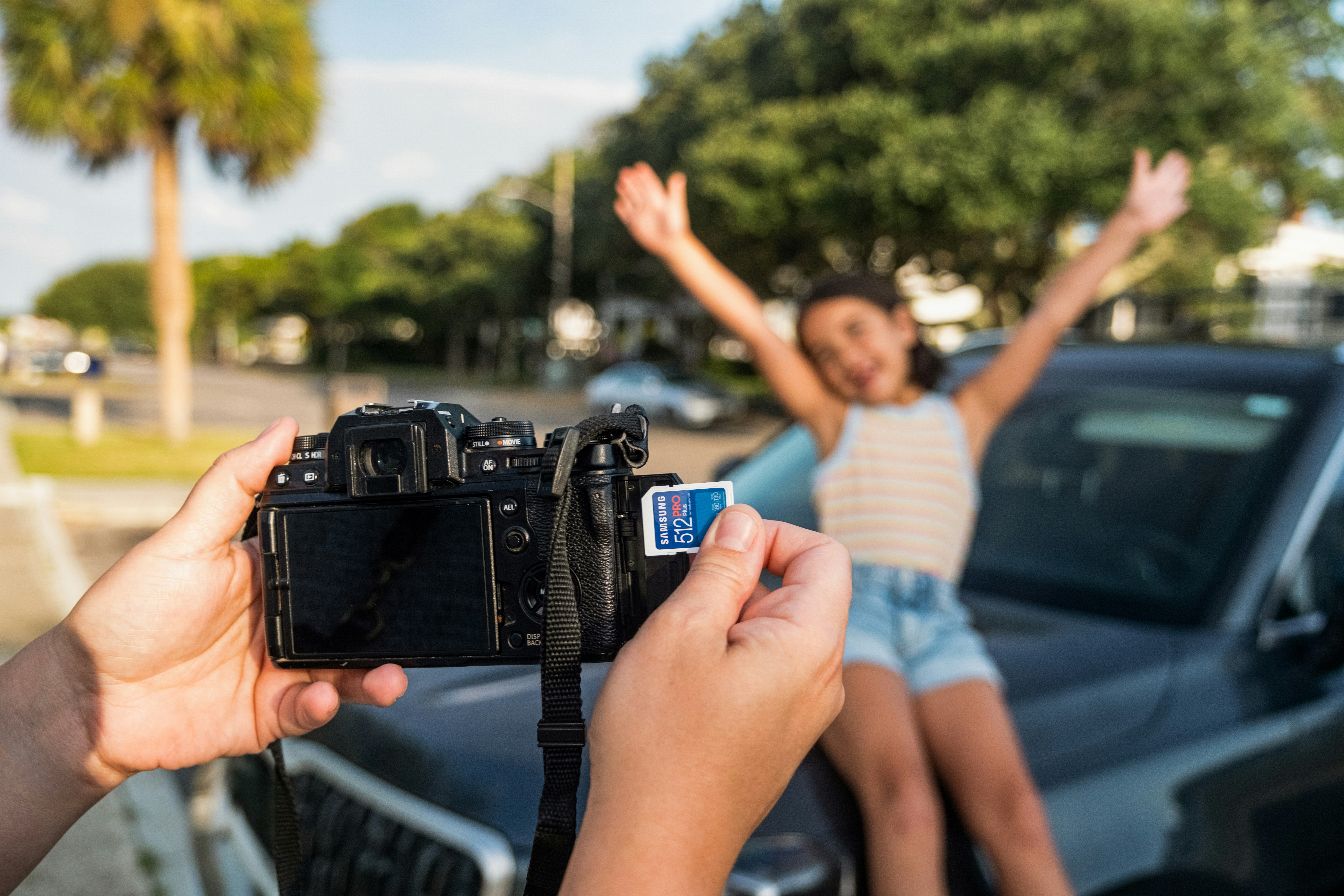 Girl posing for a picture taken with a camera.