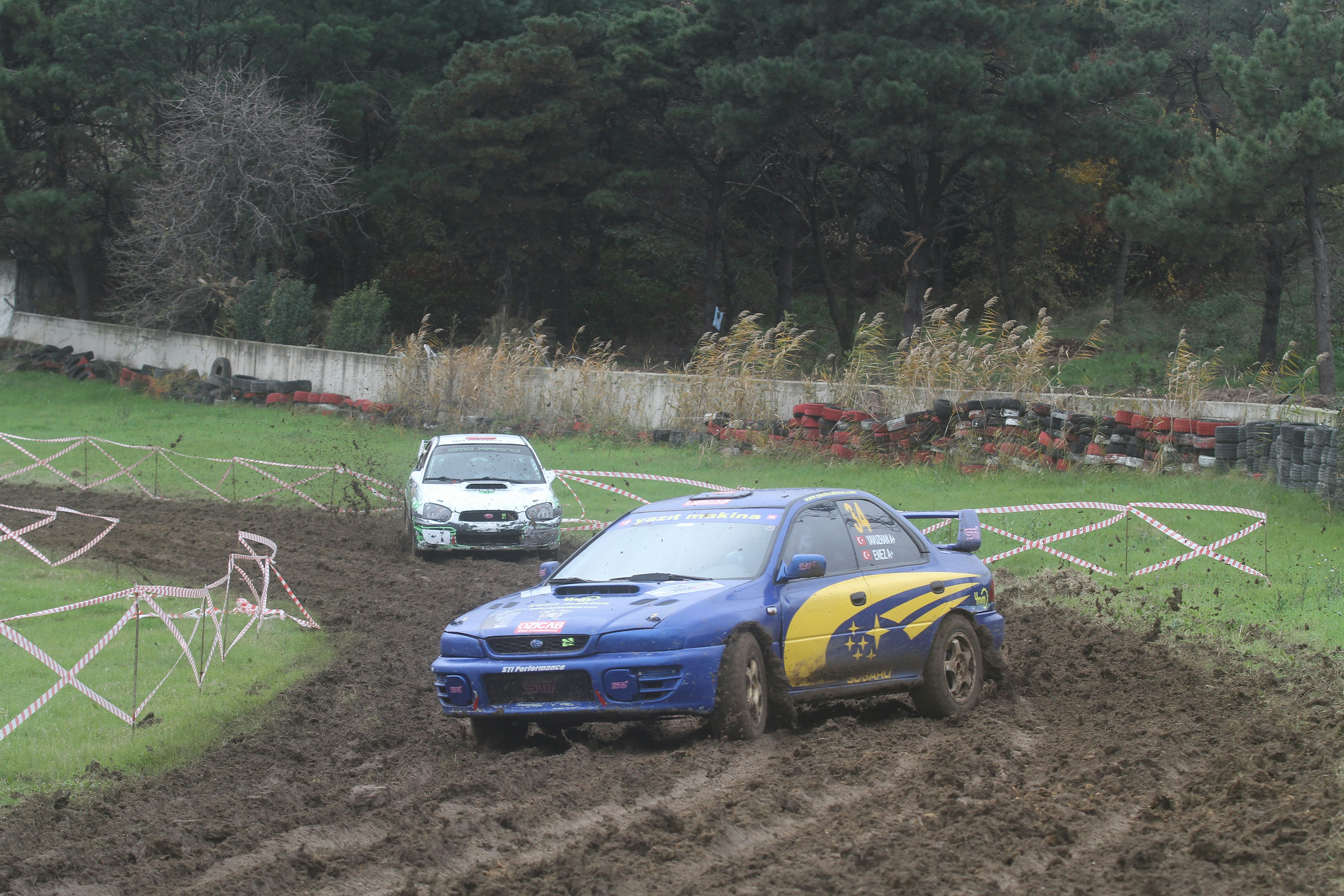 Mud-Splashed Blue Rally Car Conquers a Rural Track