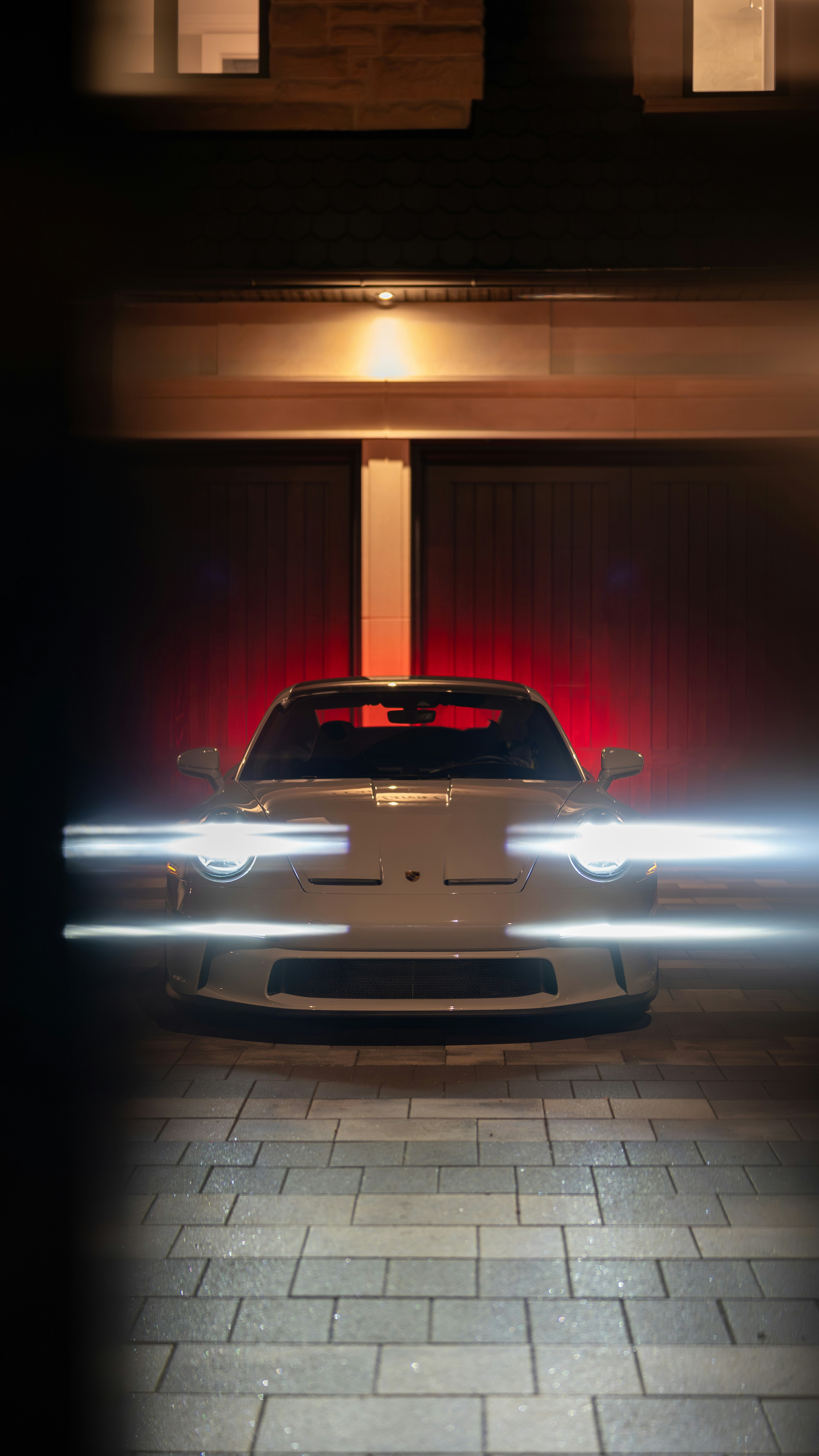 White car with bright headlights at night