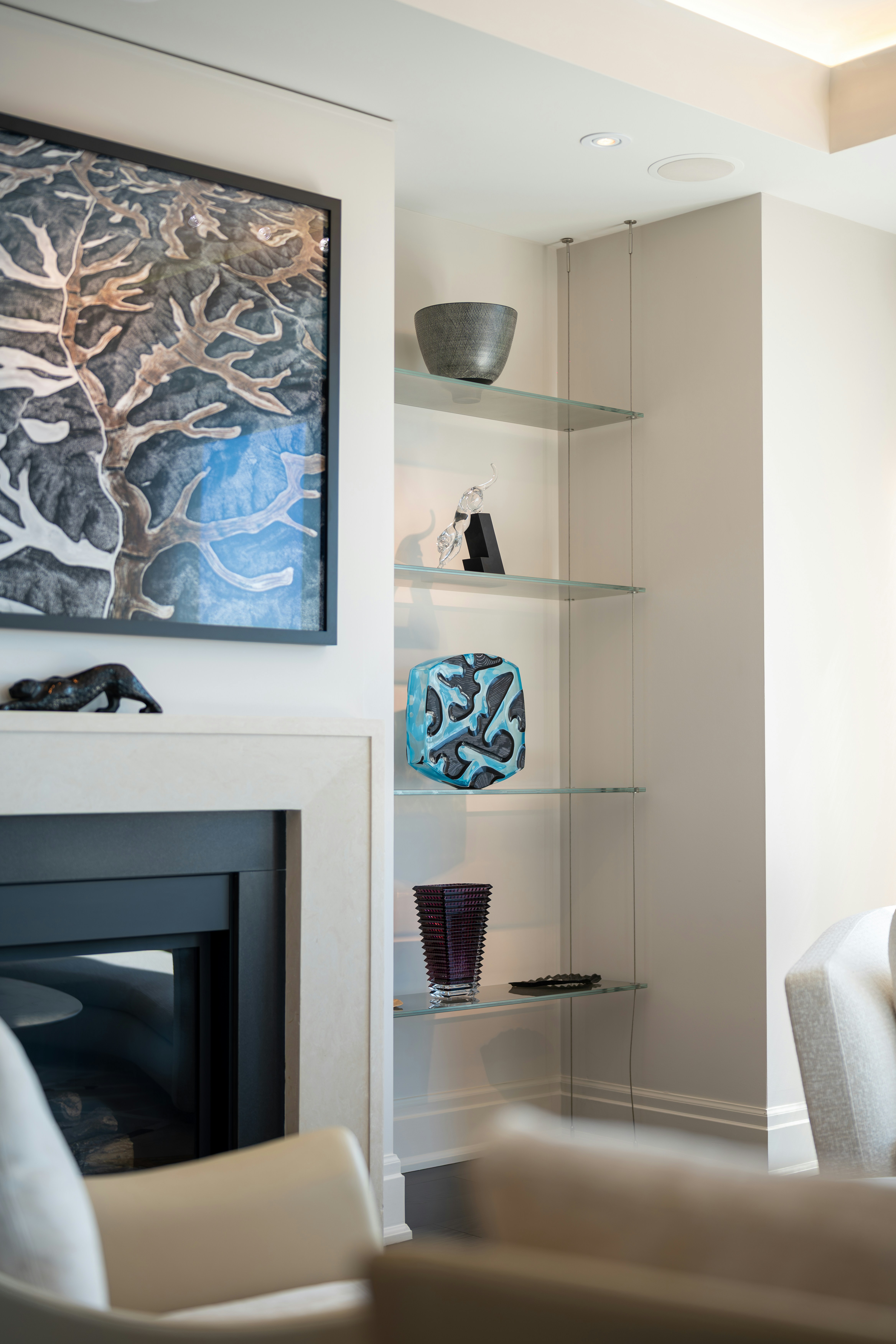 Modern living room with decorative art and shelves.
