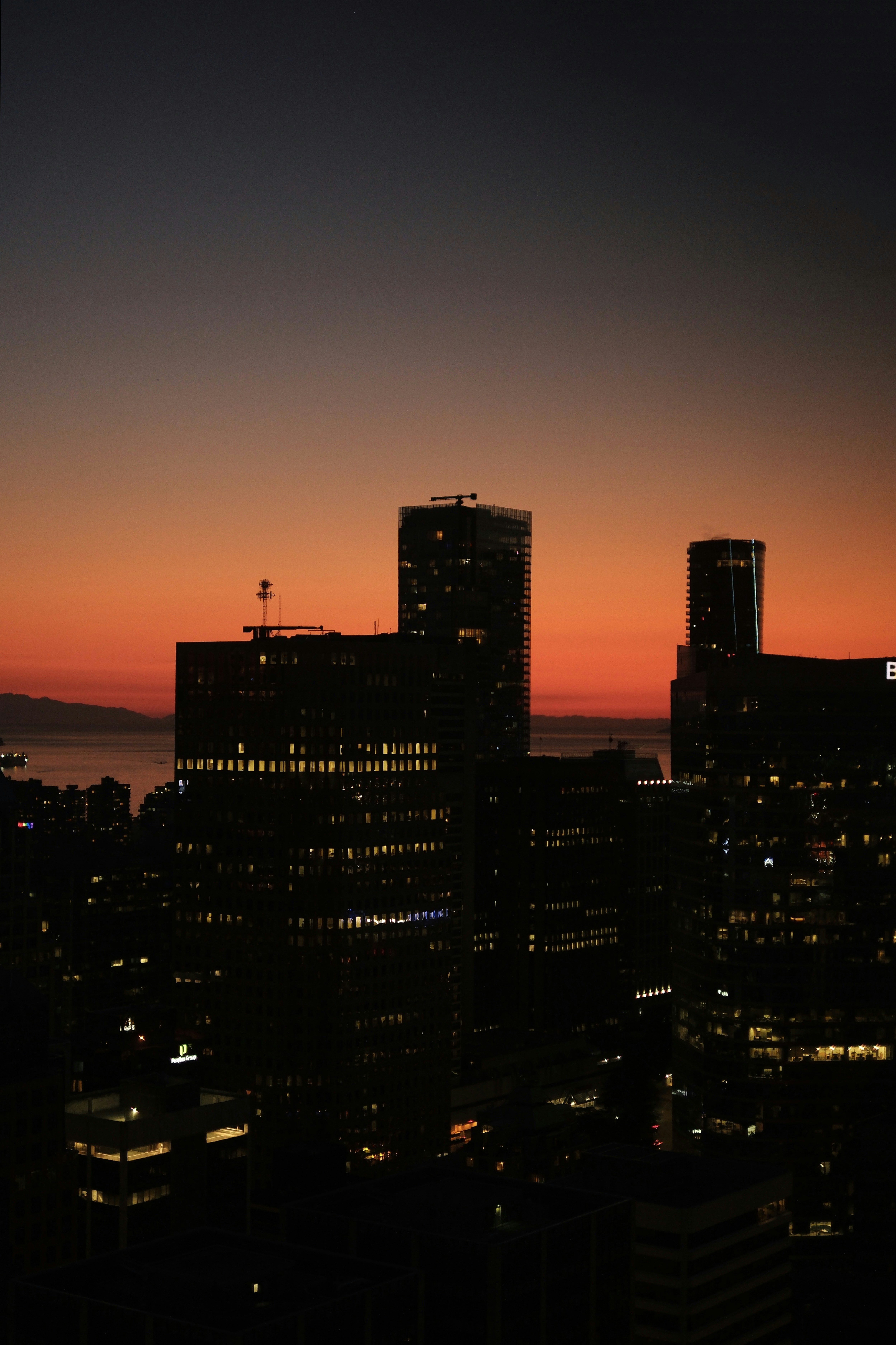 Instagram - @kaprion | City skyline at dusk with orange sunset sky.