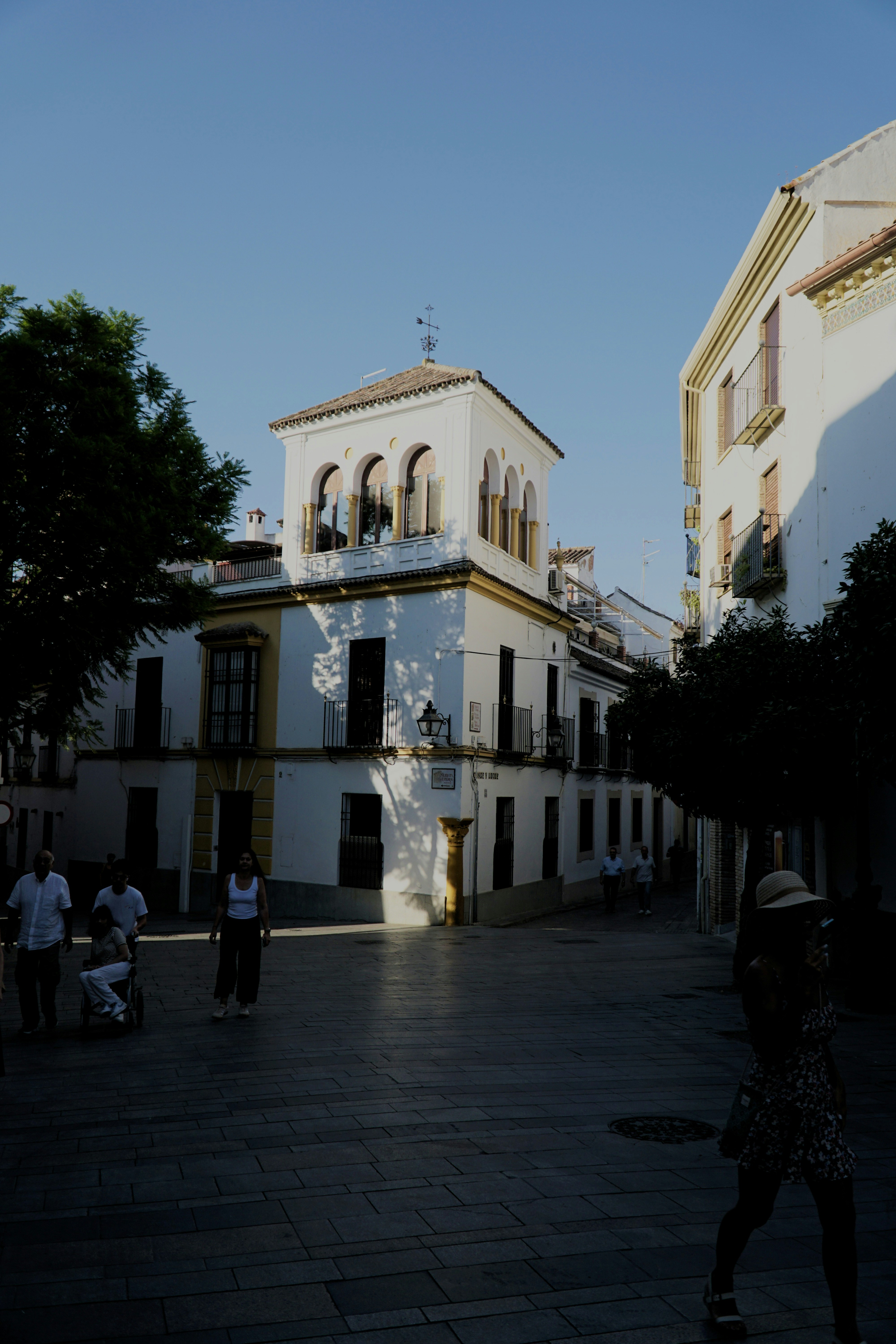 White building with arched windows and tower.