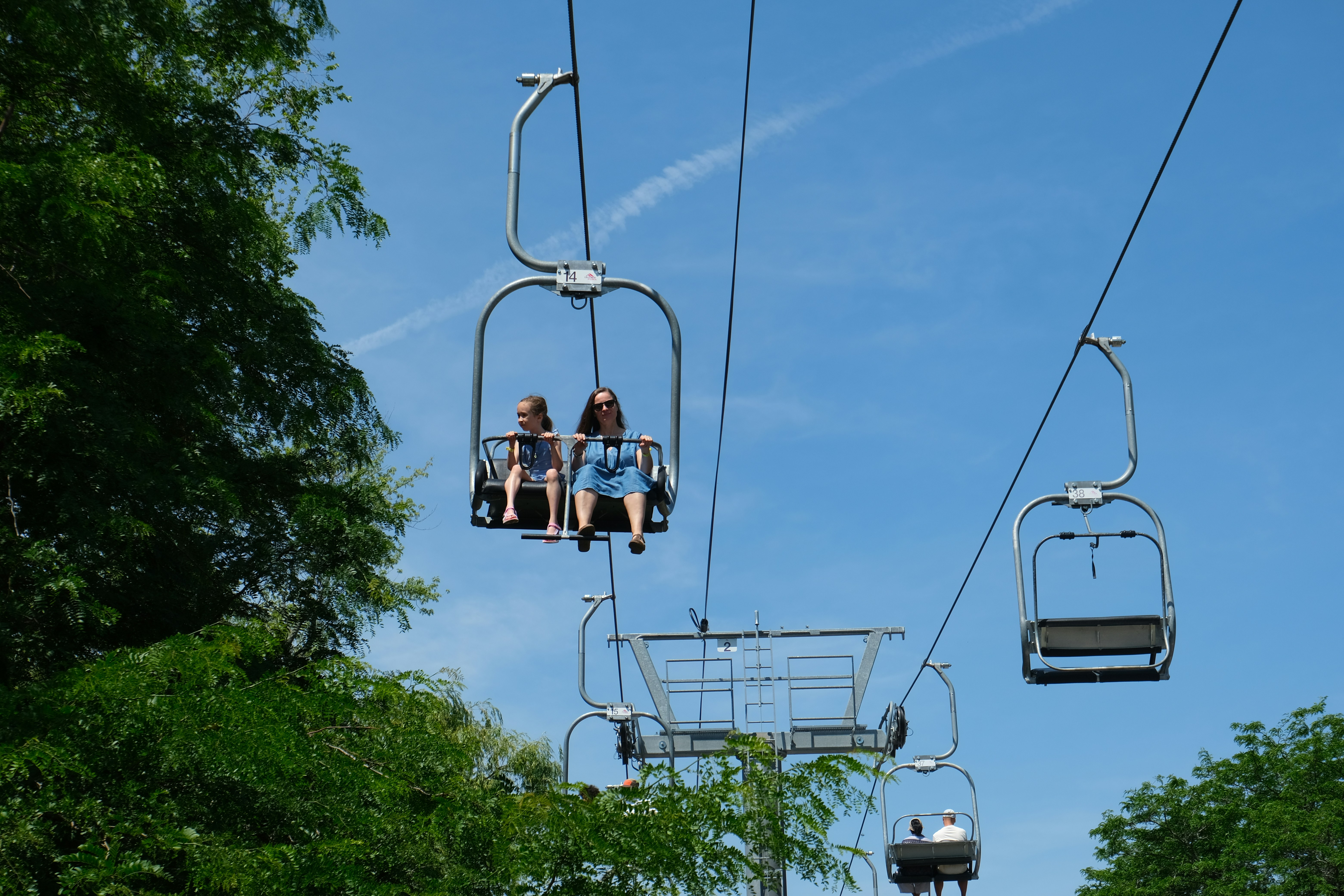 Two people ride a ski lift on a clear day. photo – Free Toronto island ...